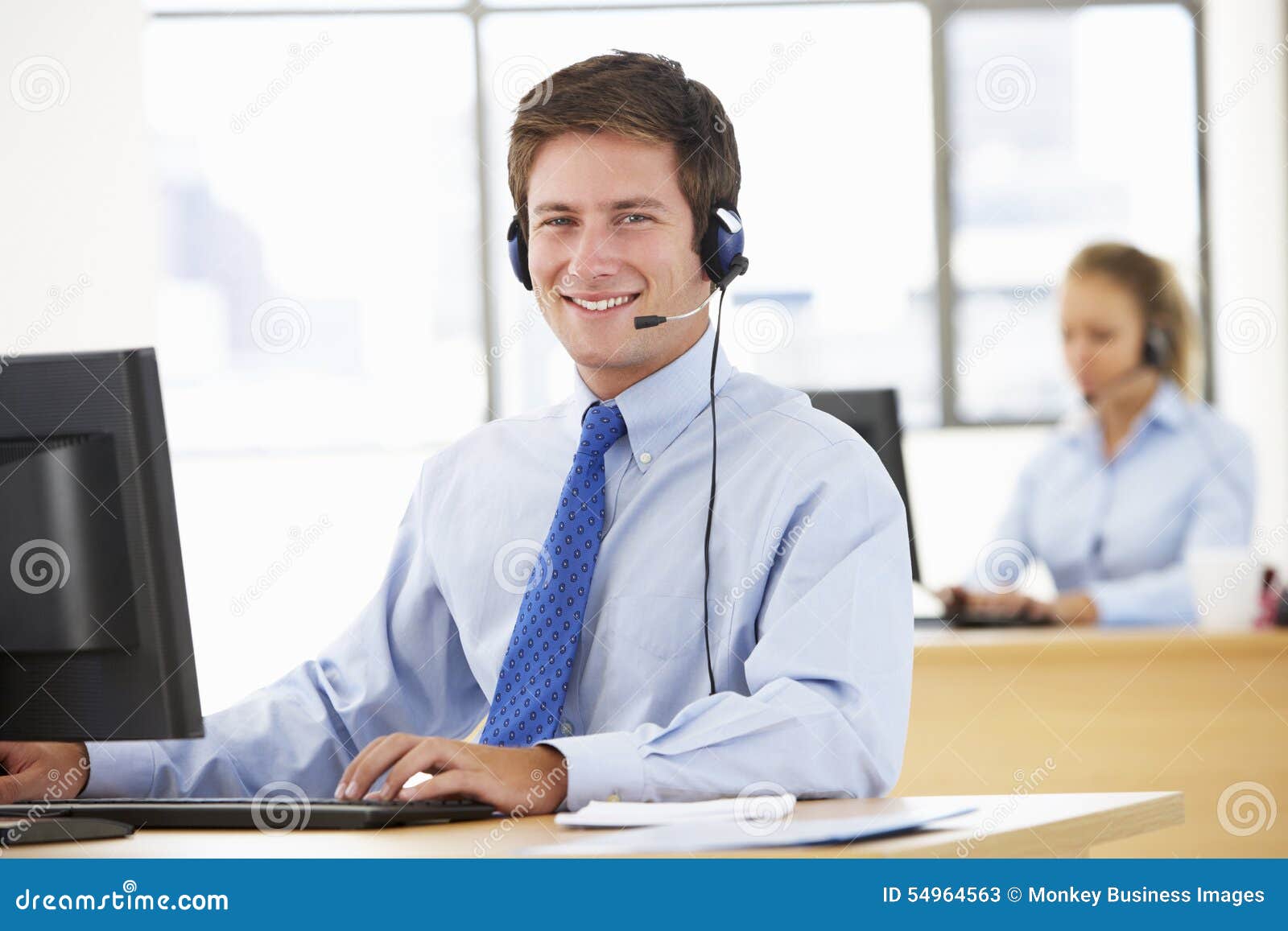 Friendly Service Agent Talking To Customer in Call Centre Stock Image ...