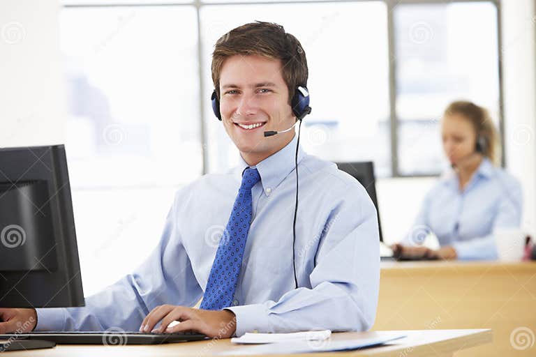 Friendly Service Agent Talking To Customer in Call Centre Stock Image ...
