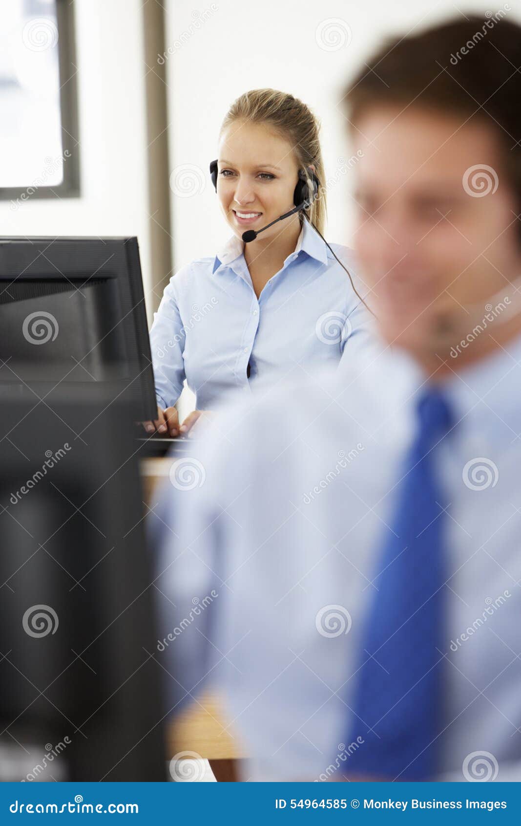 Friendly Service Agent Talking To Customer in Call Centre Stock Image ...