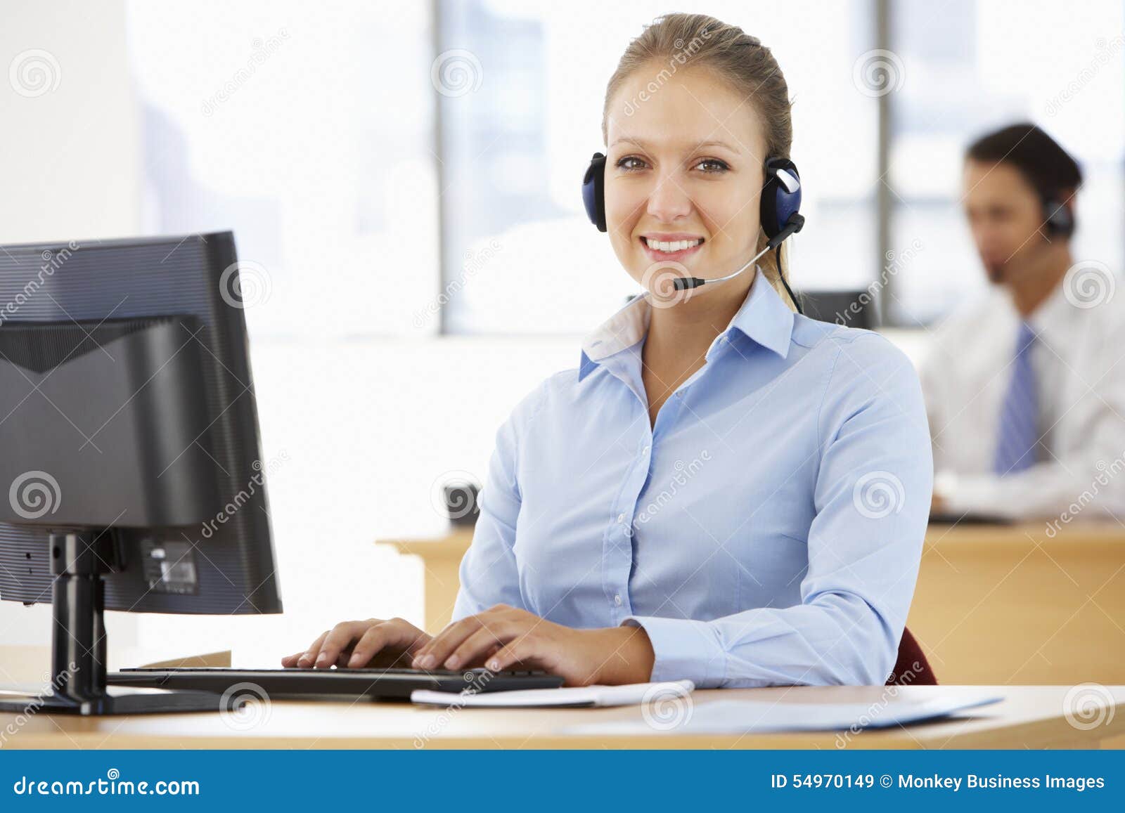Friendly Service Agent Talking To Customer in Call Centre Stock Image ...