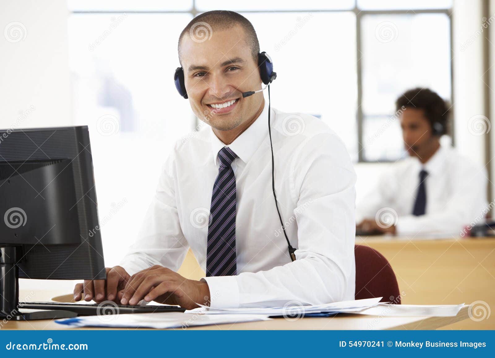 Friendly Service Agent Talking To Customer in Call Centre Stock Image ...