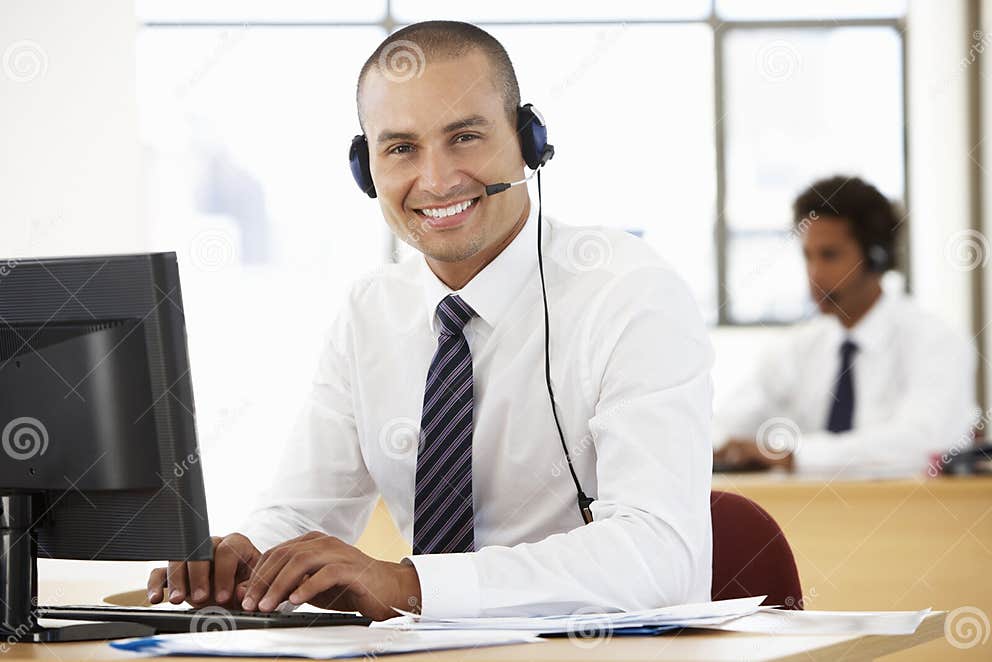 Friendly Service Agent Talking To Customer in Call Centre Stock Image ...