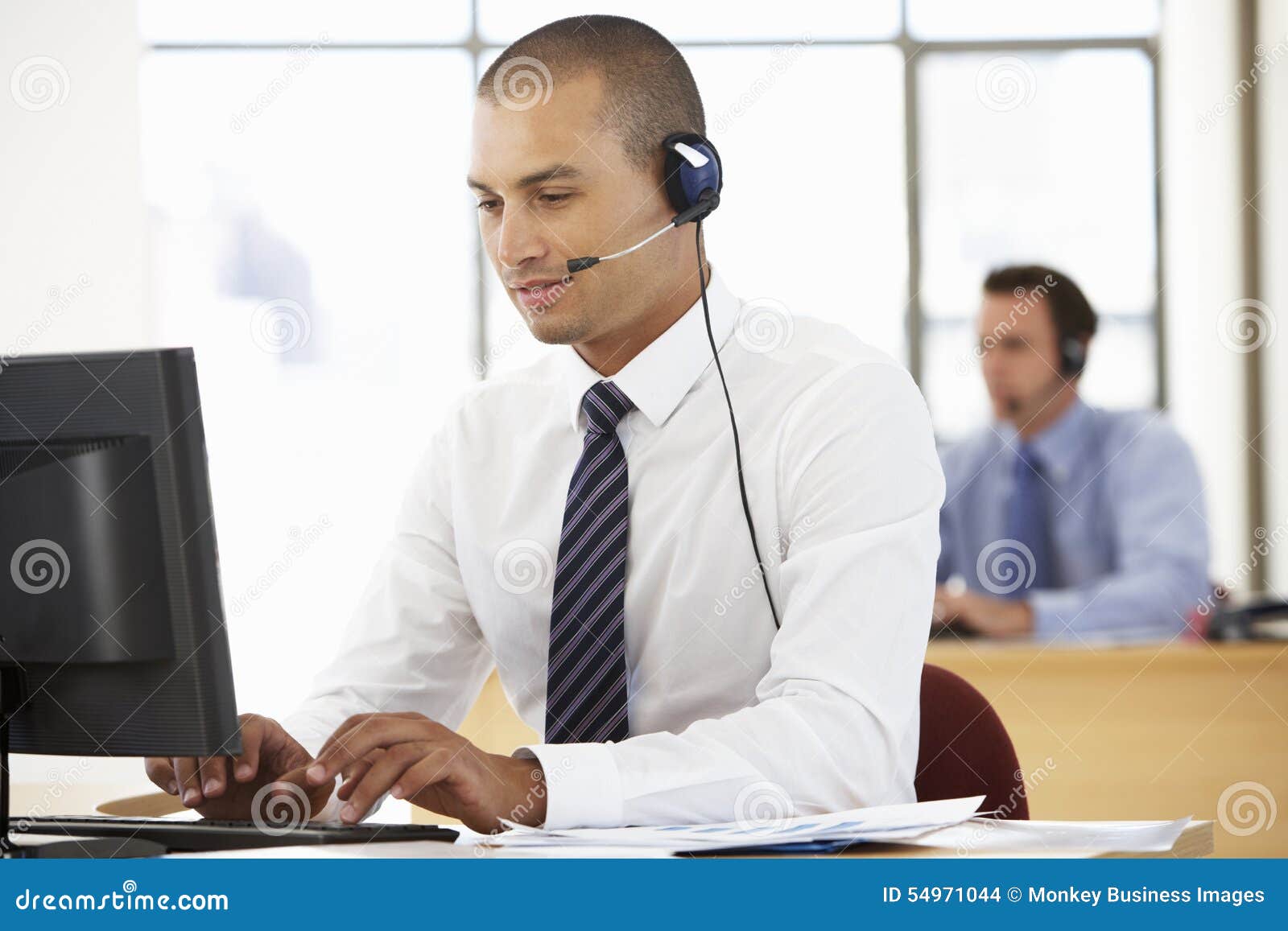 Friendly Service Agent Talking To Customer in Call Centre Stock Photo ...