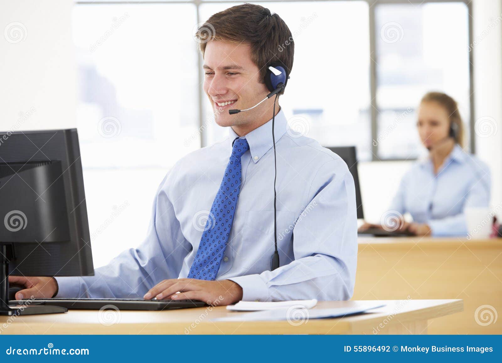 Friendly Service Agent Talking To Customer in Call Centre Stock Photo ...