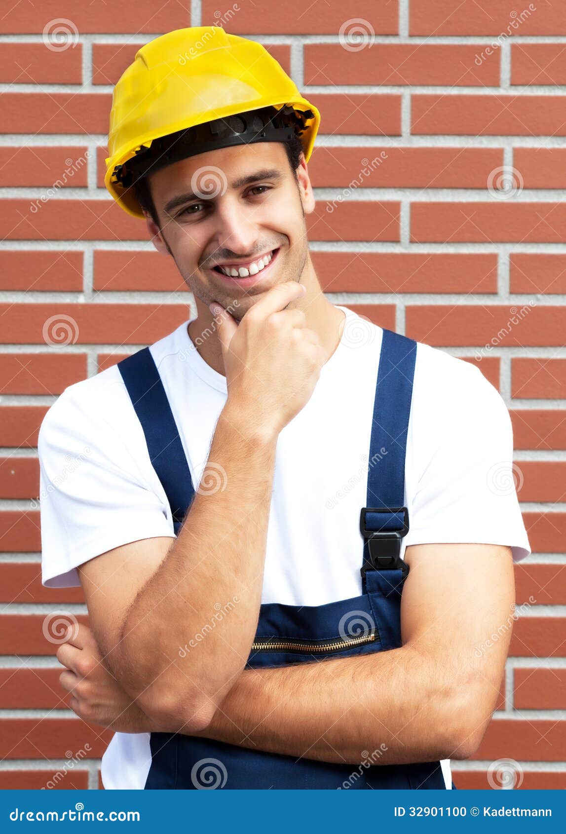 Friendly Smiling Worker in Front of a Brick Wall Stock Photo - Image of ...