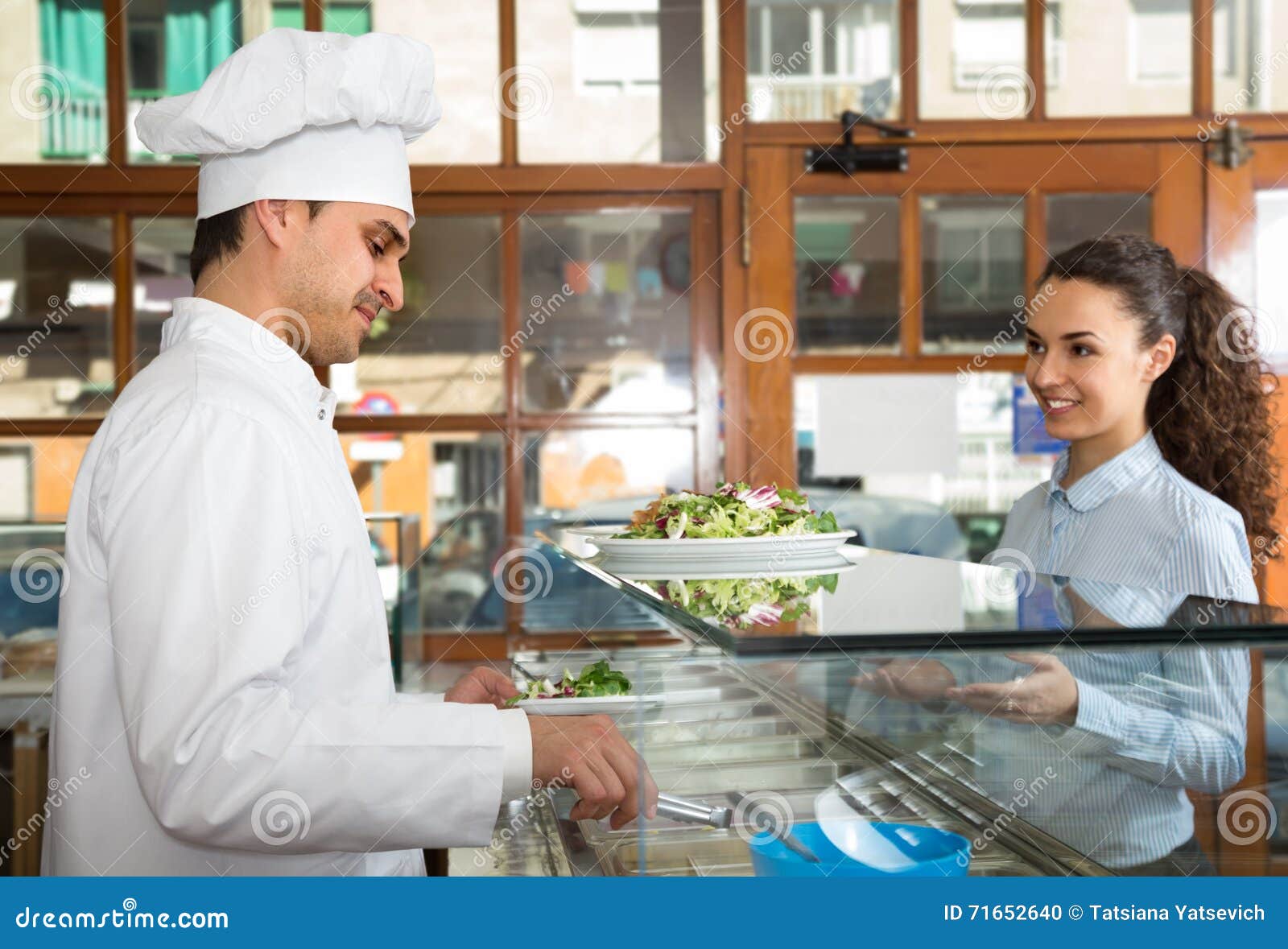 Friendly Staff and Young Female Client at Counter Stock Photo - Image ...