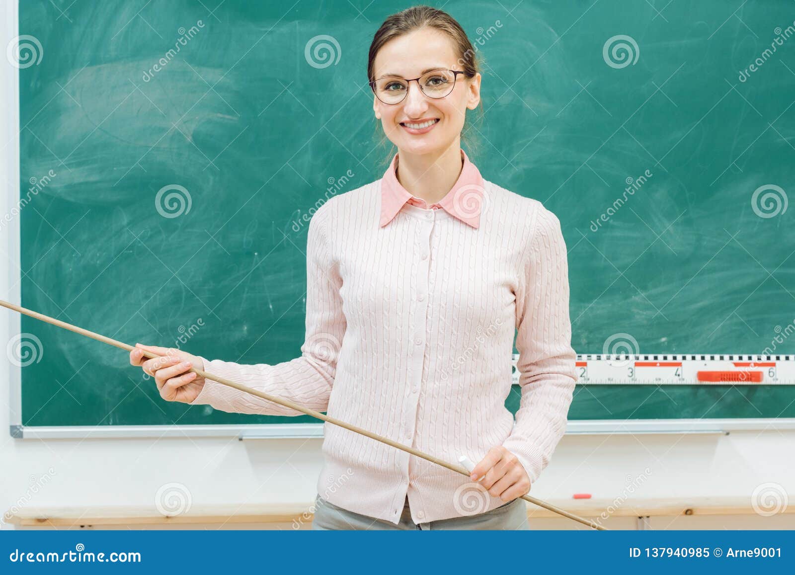 Friendly Teacher Standing in Front of Blackboard in Class Stock Image ...