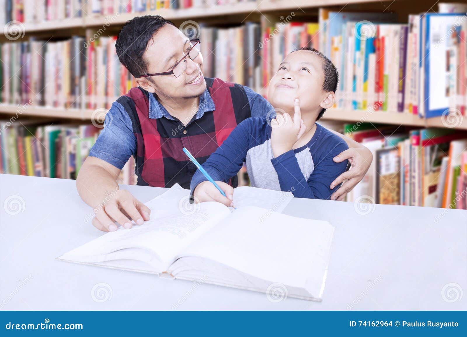 Friendly Teacher Teaching Student in Library Stock Photo - Image of ...