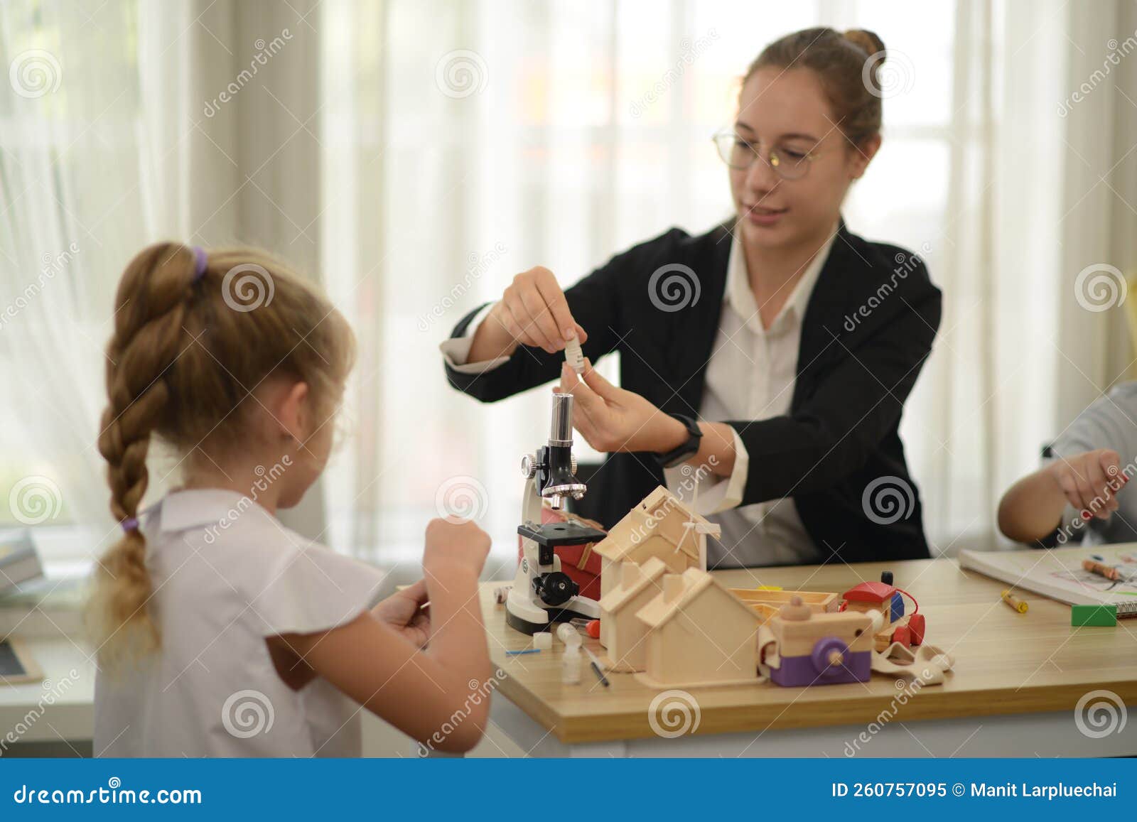 Friendly Teachers Help Elementary School Students in Class. Stock Image ...