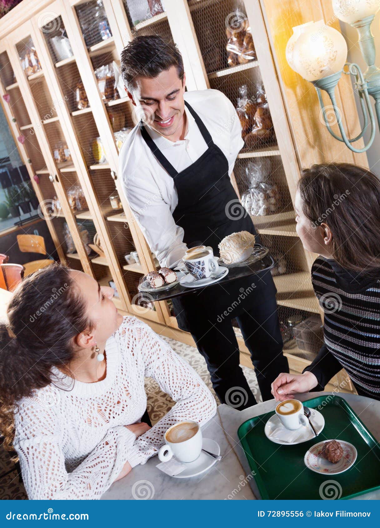 Friendly Waitress Serving Cakes and Pastry for Girls Stock Photo ...