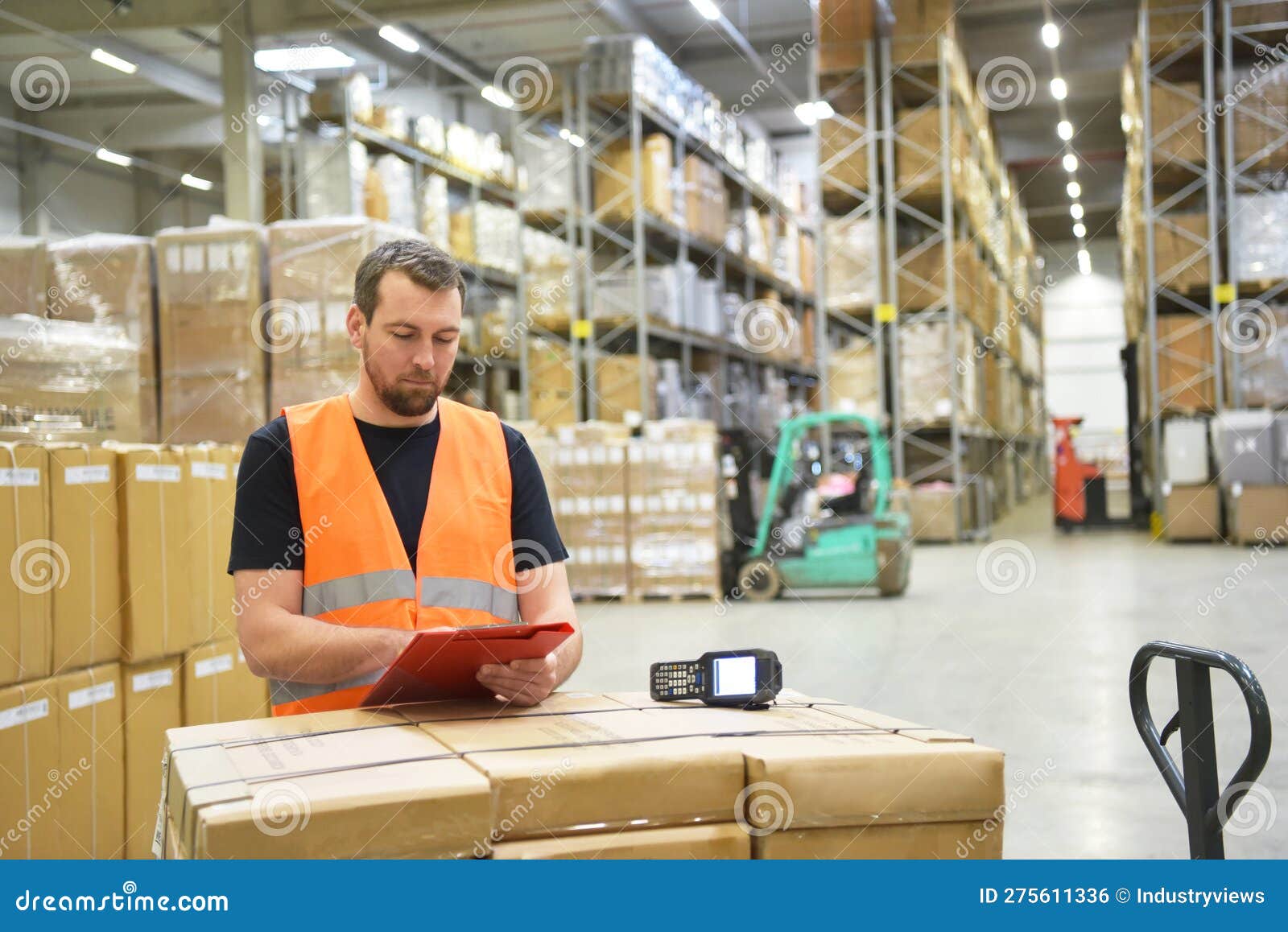 Friendly Warehouse Worker in a Warehouse with the Barcode Scanner Stock ...