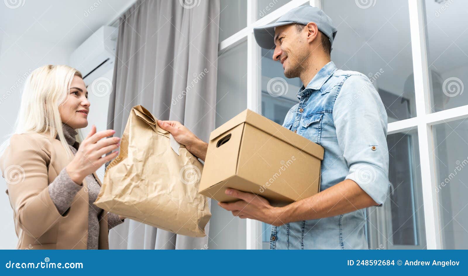 Friendly Young Delivery Man Delivering a Package Stock Photo - Image of ...