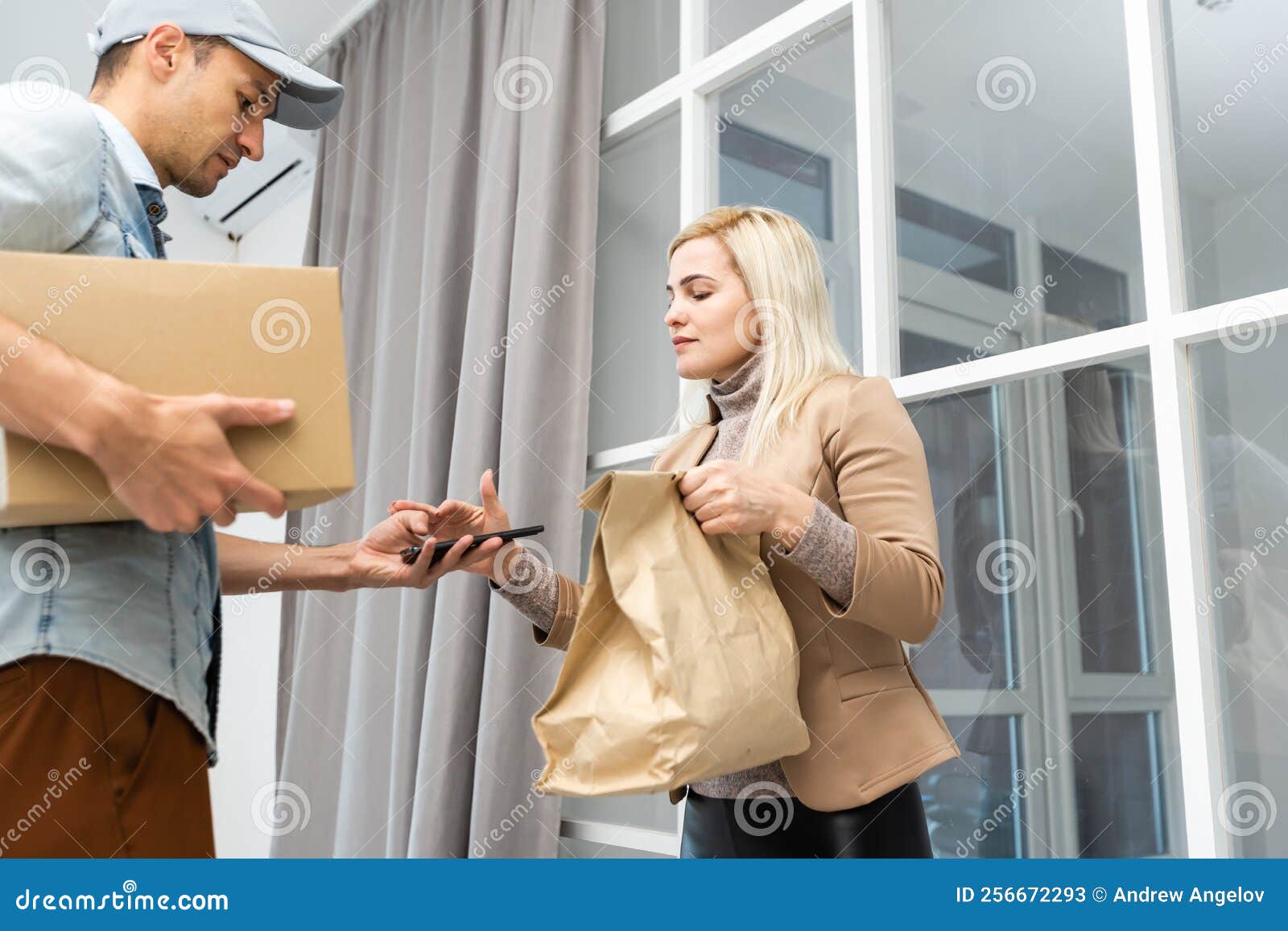 Friendly Young Delivery Man Delivering a Package Stock Image - Image of ...
