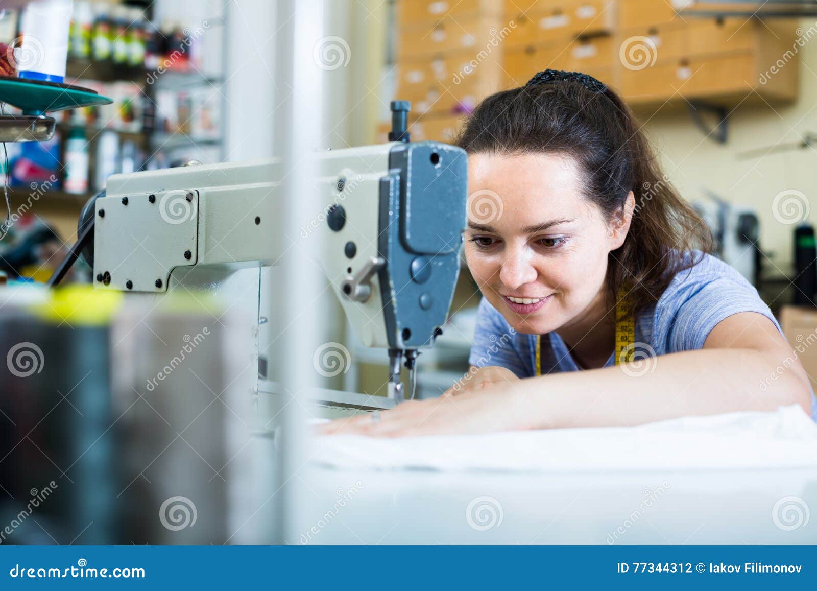 Friendly Young Professional Female Tailor Using Sewing Machine Stock ...