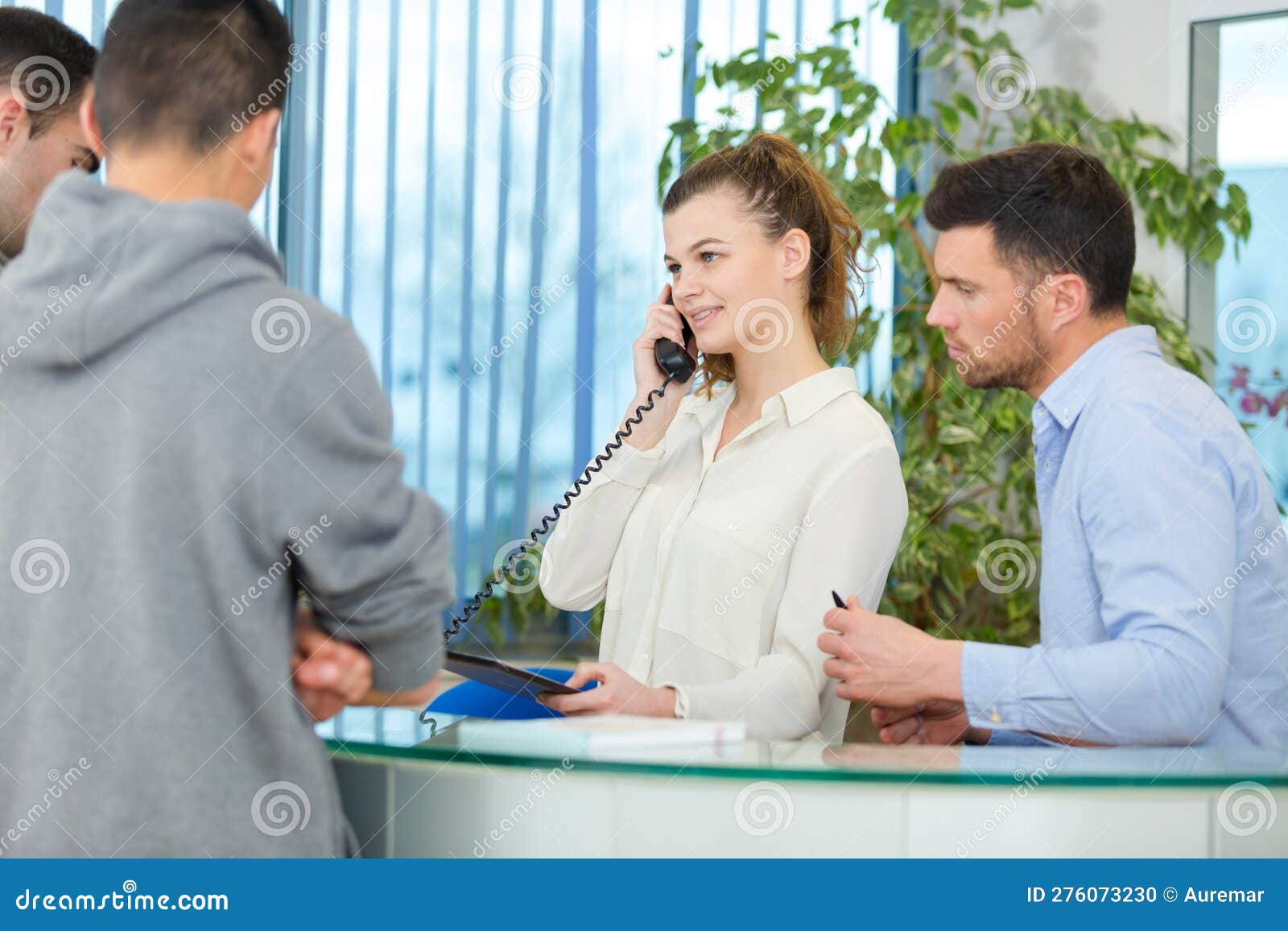 Friendly Young Woman Behind Reception Desk Administrator Stock Photo ...