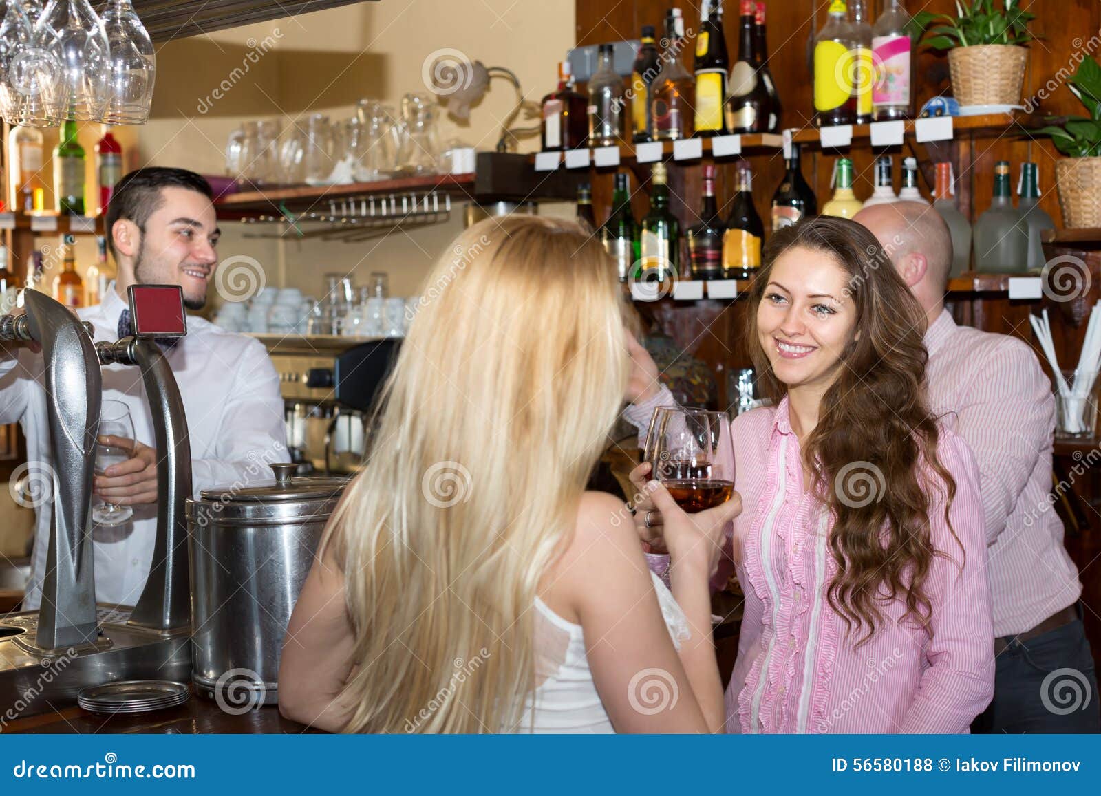 Friends at bar with barman stock photo. Image of european - 56580188