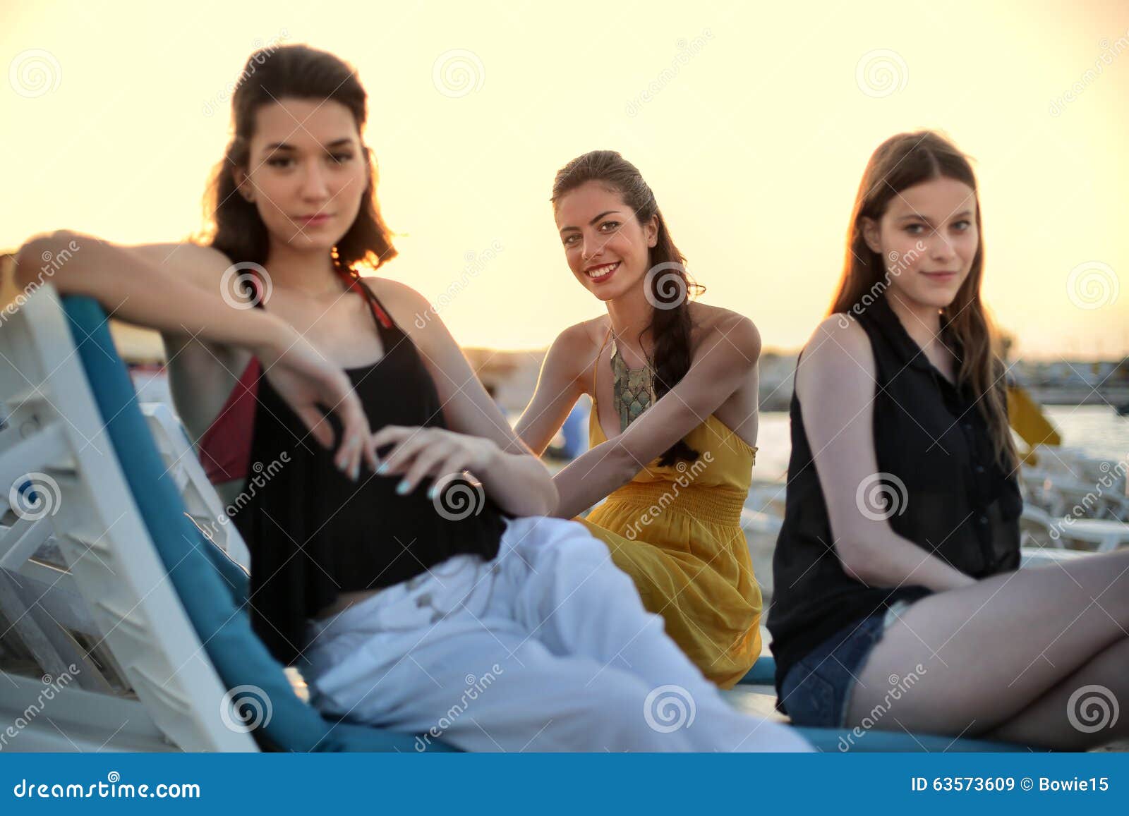 Friends at the beach stock image. Image of chair, summer - 63573609