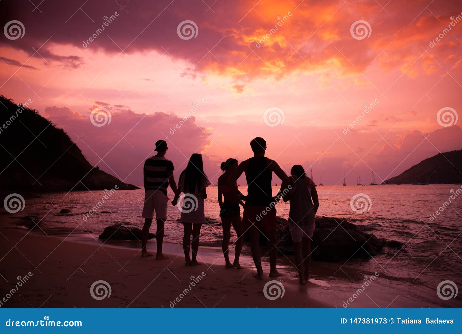 Friends on beach at sunset stock image. Image of group - 147381973