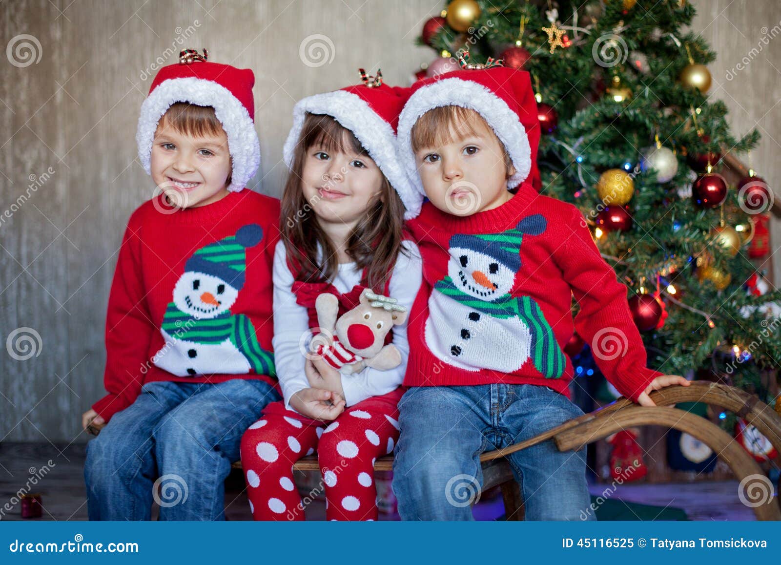 Friends on Christmas - Three Kid, Sitting on a Sledge Indoor, Smiling ...
