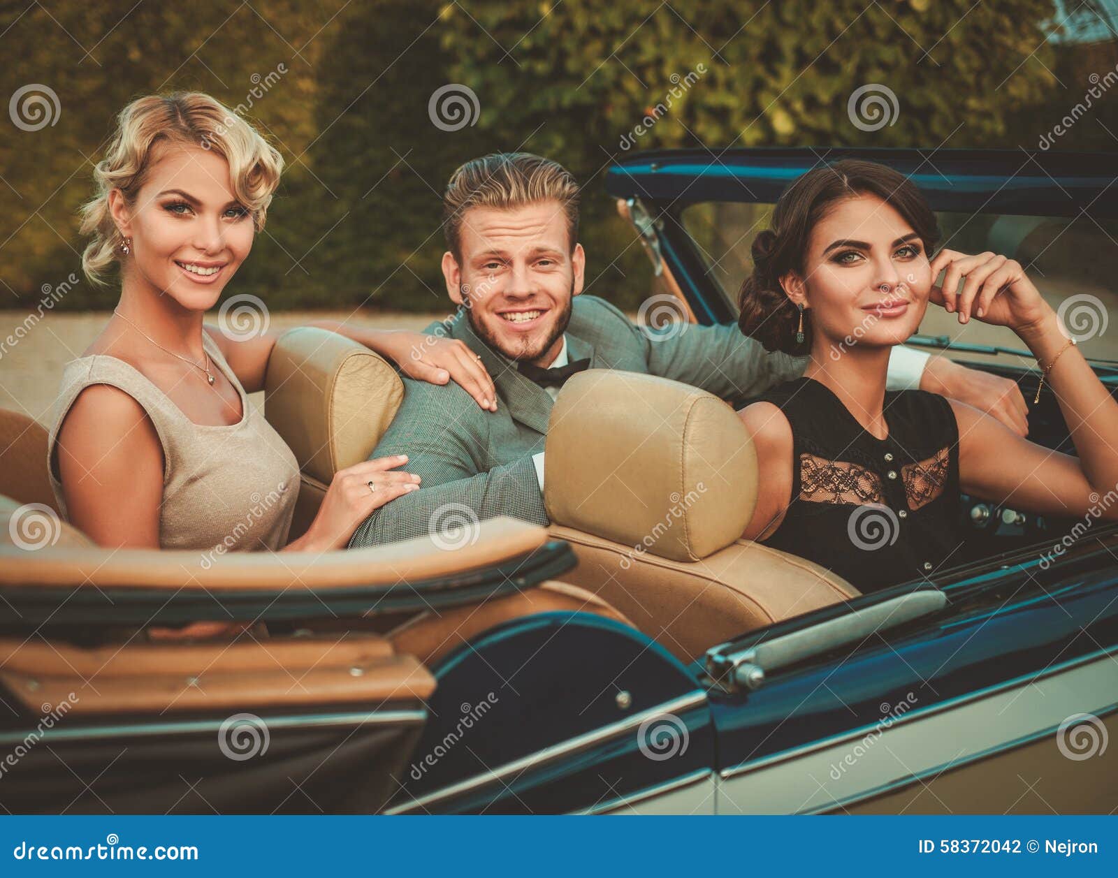 Friends in a classic car stock photo. Image of garden - 58372042