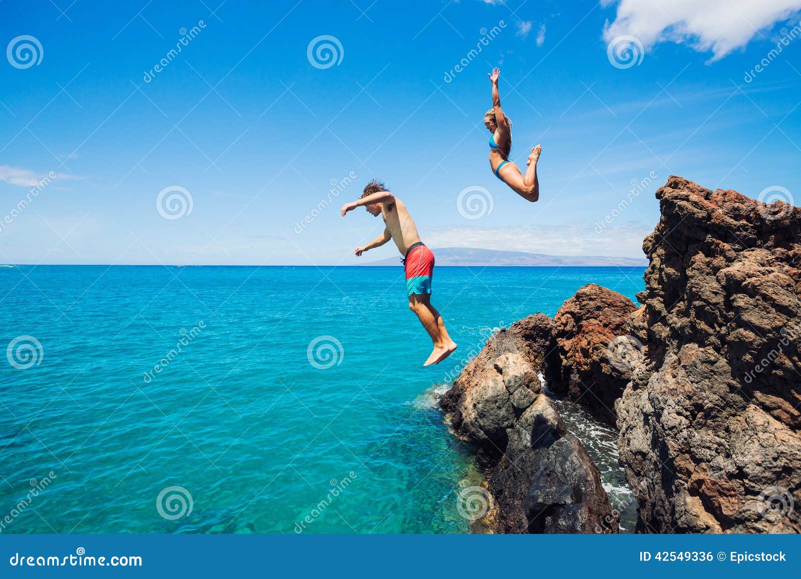 Friends Cliff Jumping into the Ocean Stock Photo - Image of cliff ...