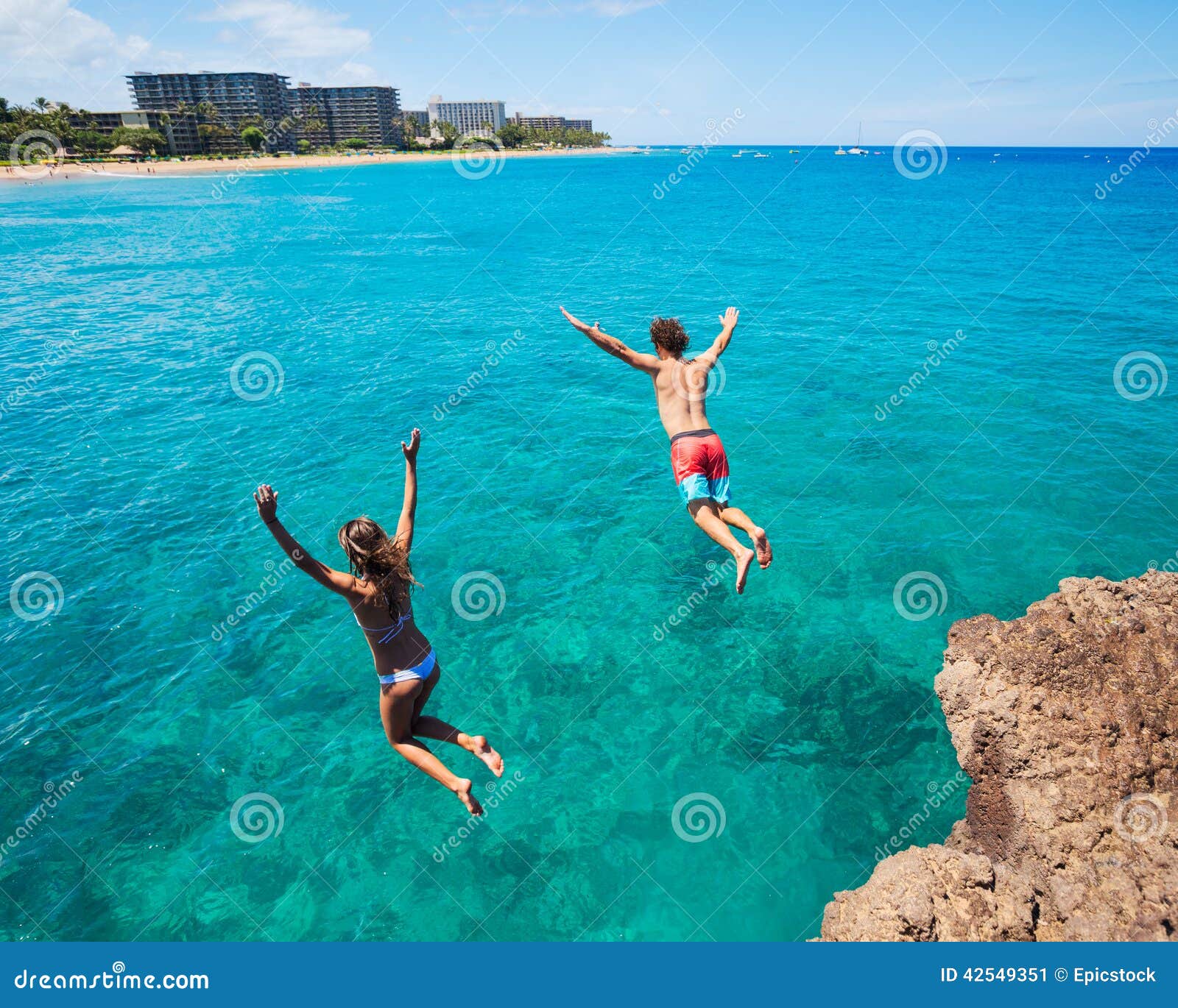 Friends Cliff Jumping into the Ocean Stock Image - Image of island ...