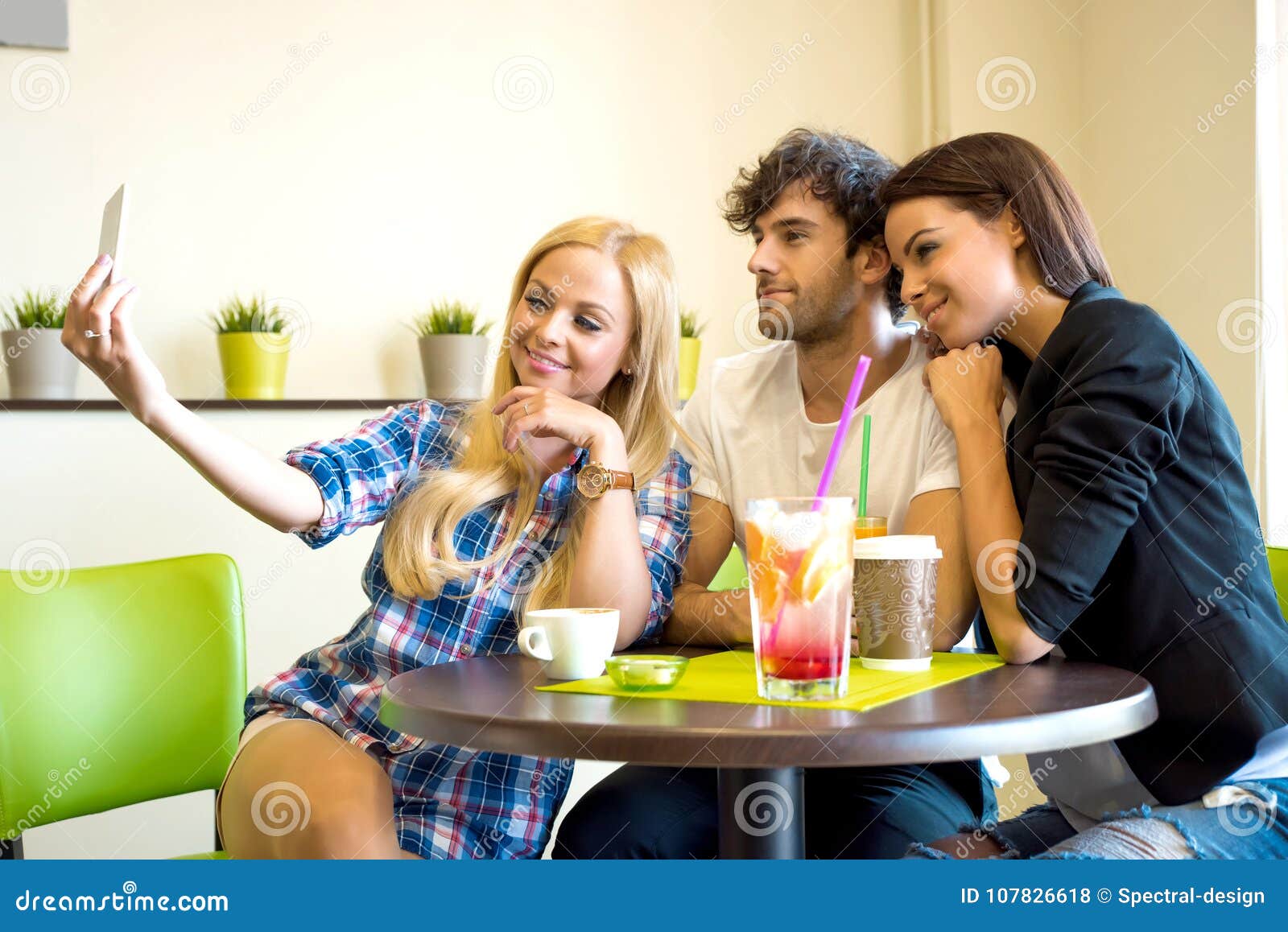 Friends in a coffee shop stock photo. Image of phone - 107826618