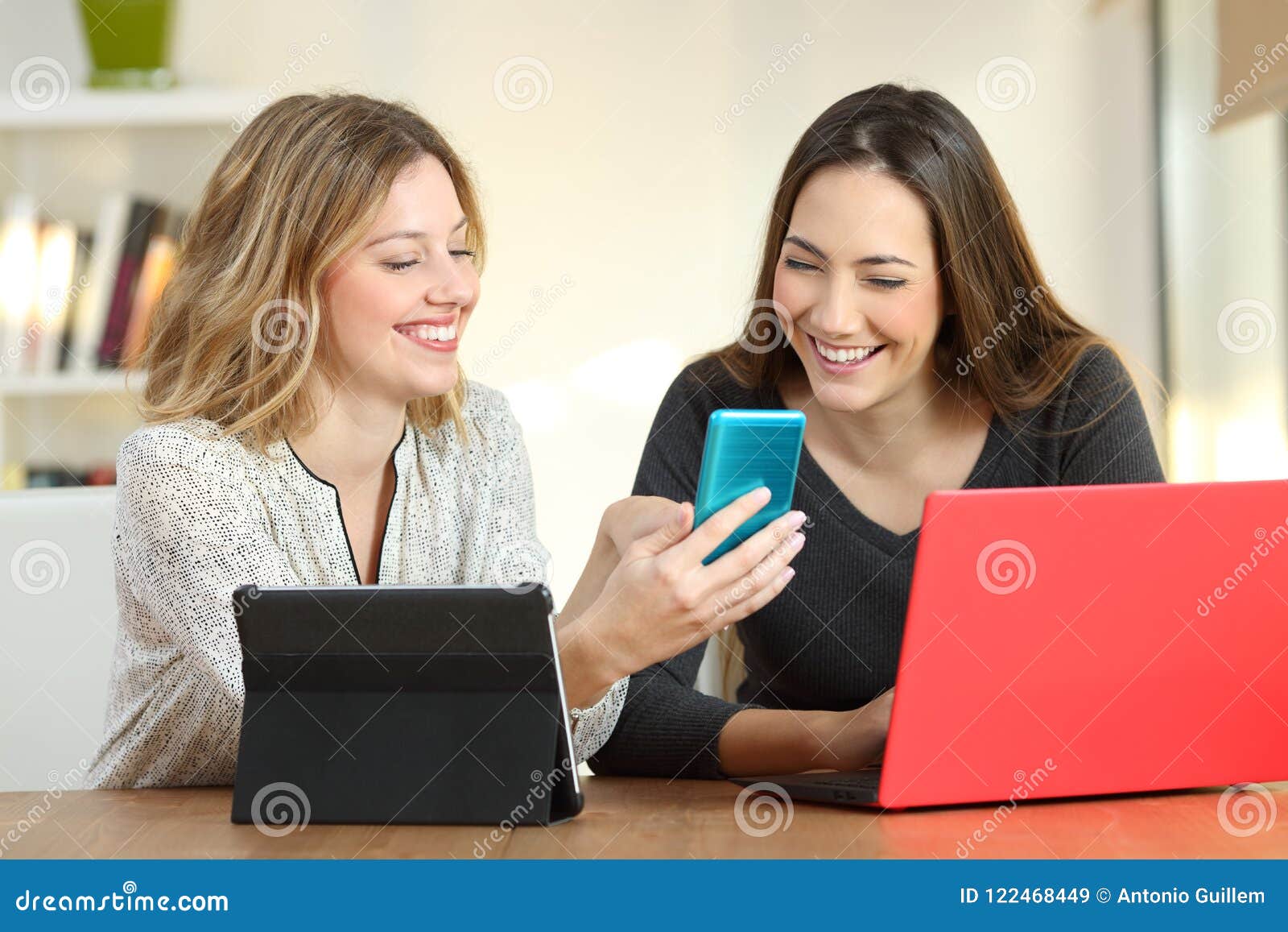 Friends Consulting Multiple Devices at Home Stock Image - Image of ...