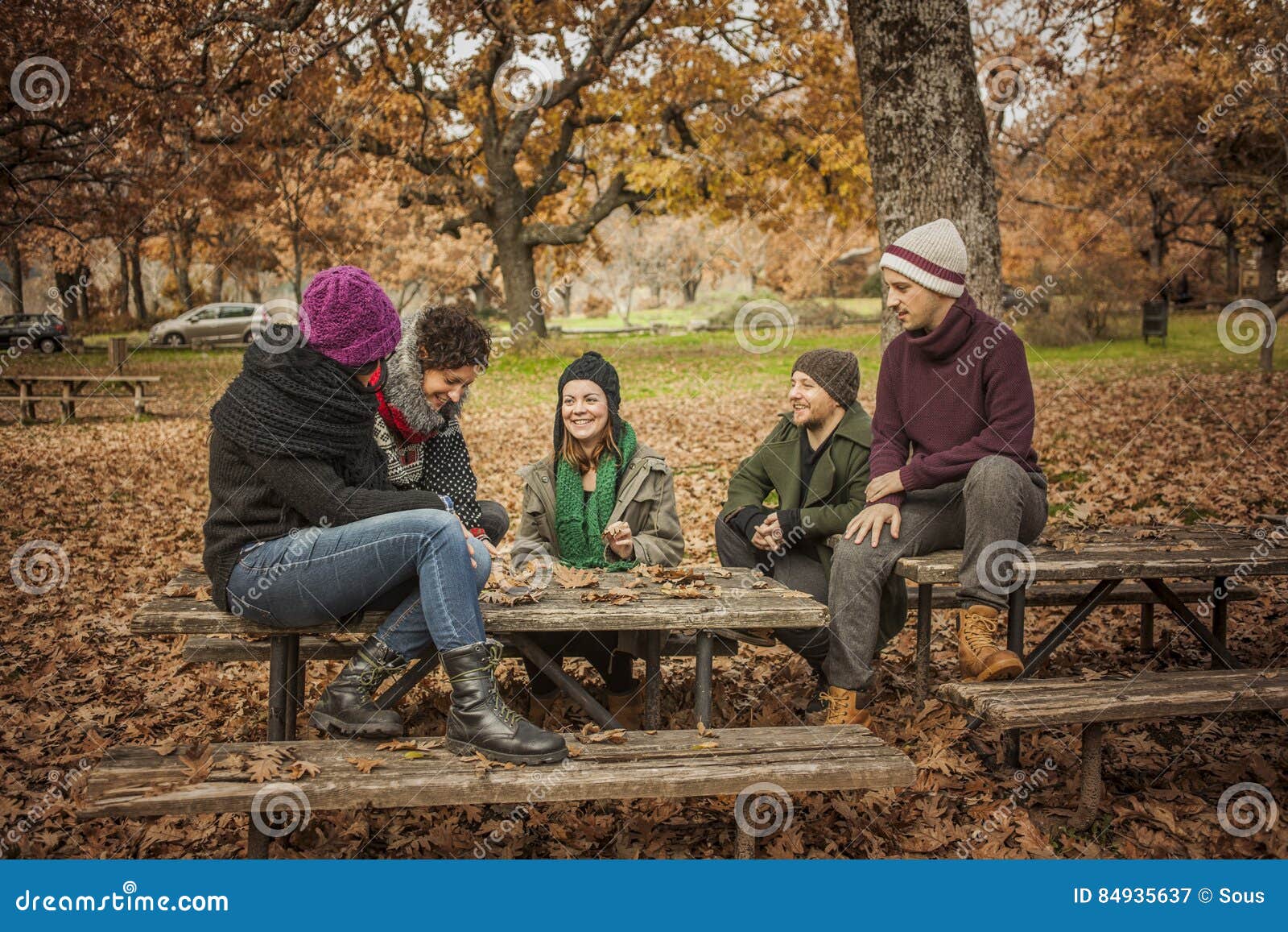 Friends Conversation in a Park Full of Leaves. Stock Image - Image of ...