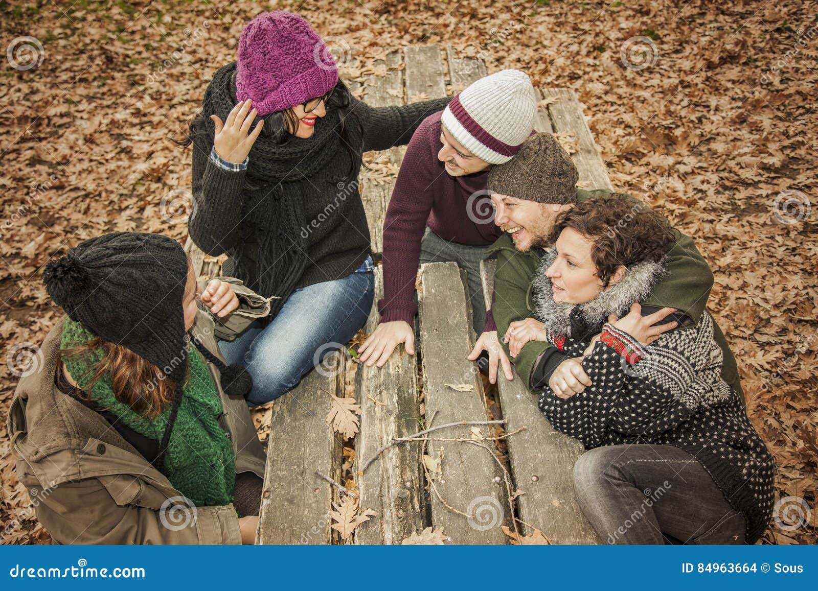 Friends Conversation in a Park Full of Leaves. Stock Photo - Image of ...