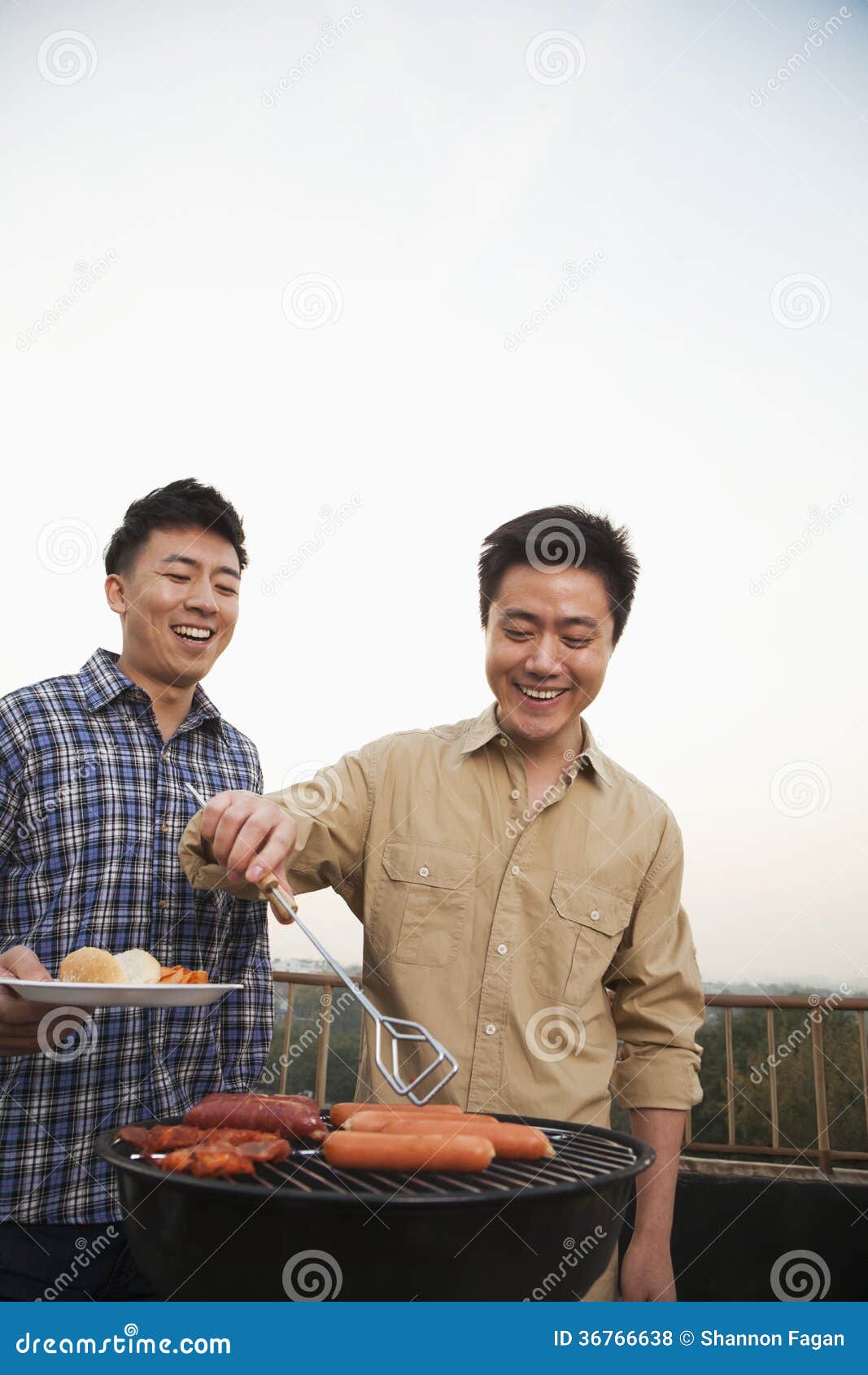 Friends Cooking Over a Grill Stock Photo - Image of drink, friendship ...