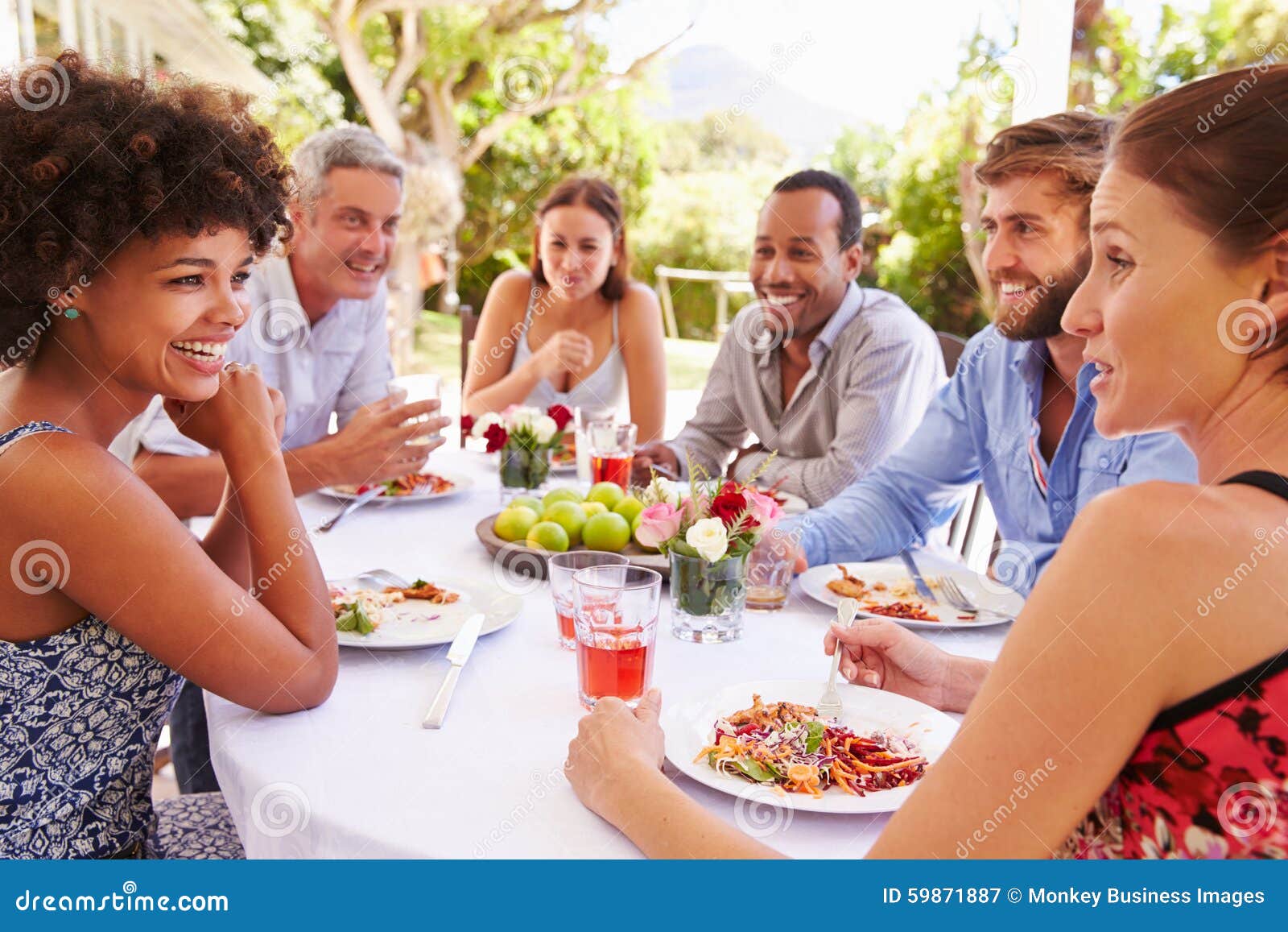 Friends Dining Together at a Table in a Garden Stock Image - Image of ...