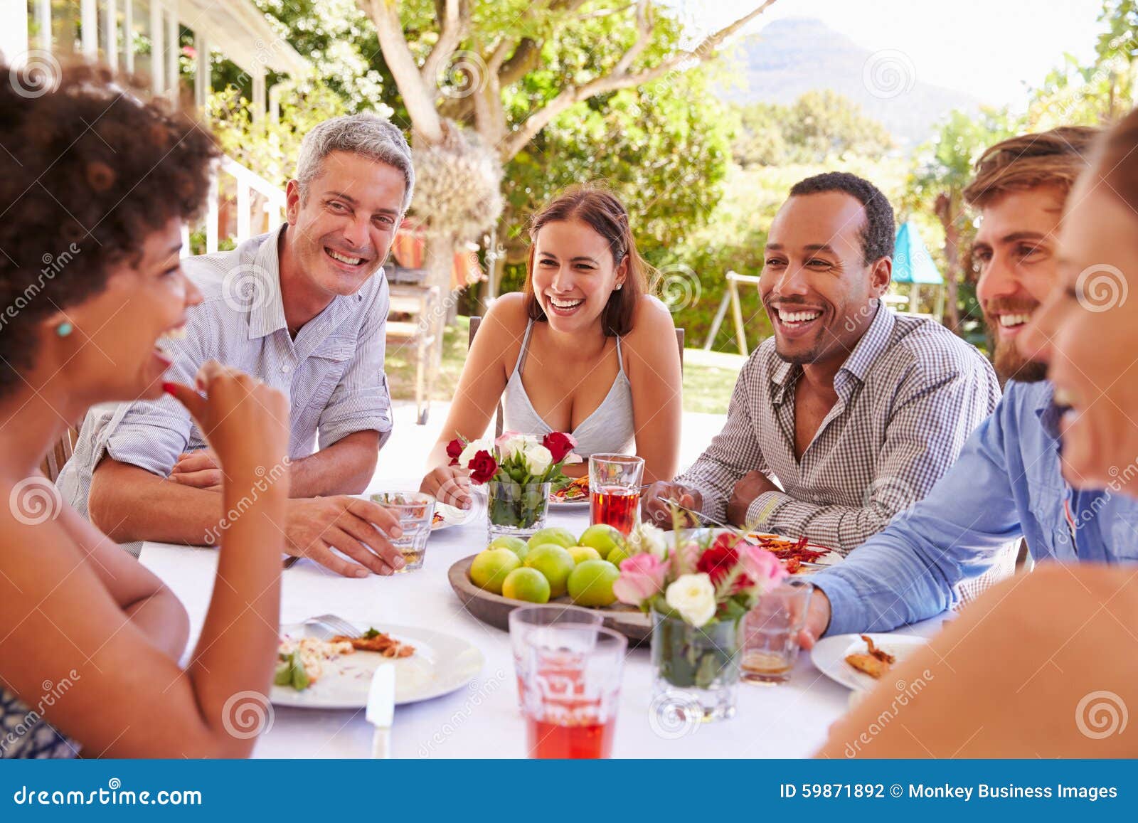 Friends Dining Together at a Table in a Garden Stock Photo - Image of ...