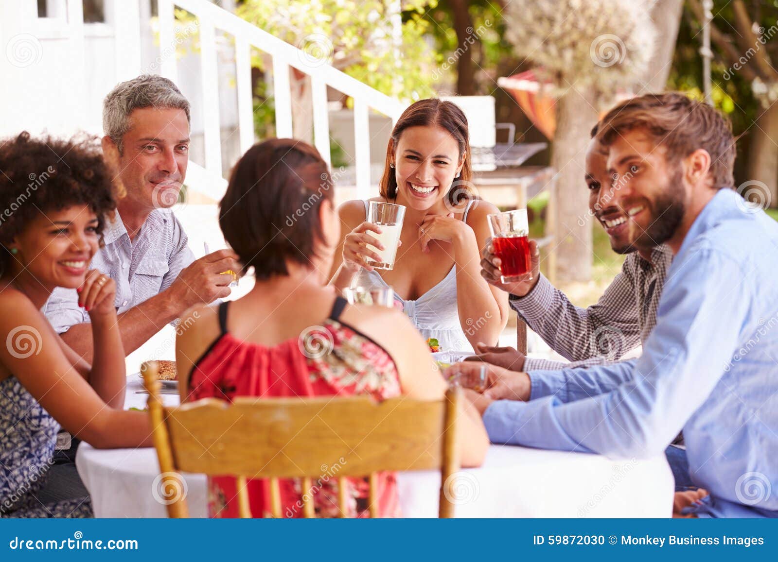 Friends Dining Together at a Table in a Garden Stock Photo - Image of ...