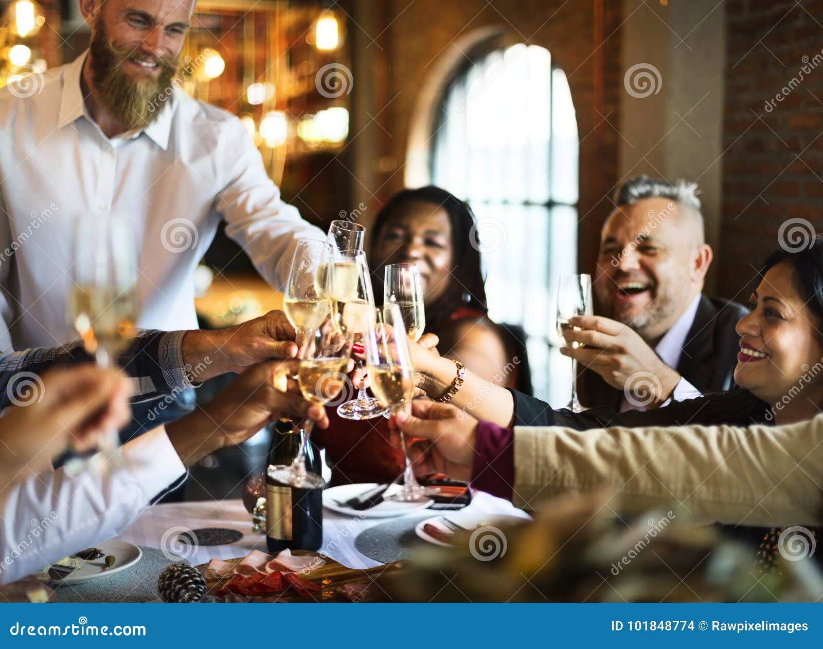 Friends at a dinner party stock photo. Image of cheers - 101848774