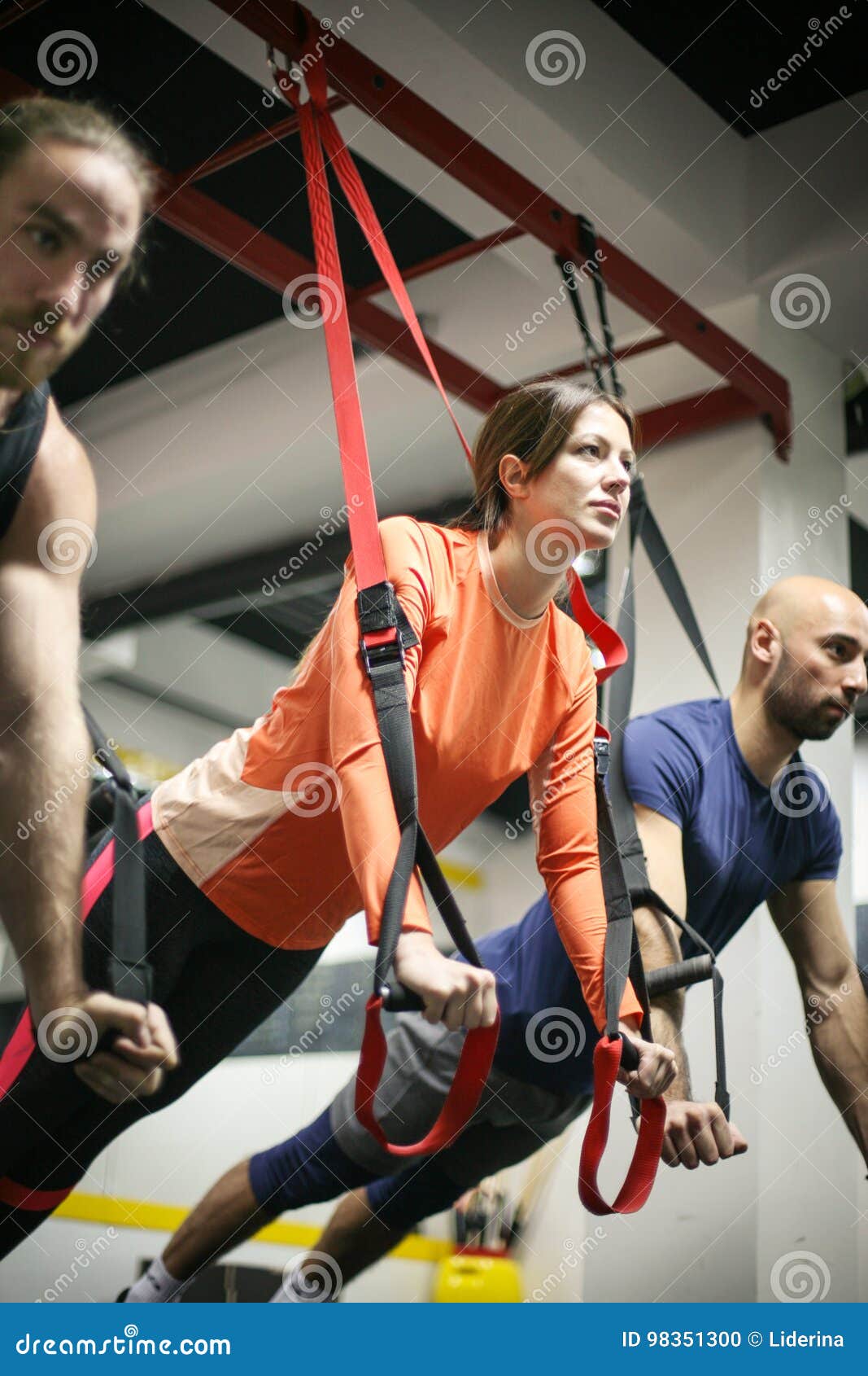 Friends Doing Exercises in a Gym with Straps. Stock Photo - Image of ...