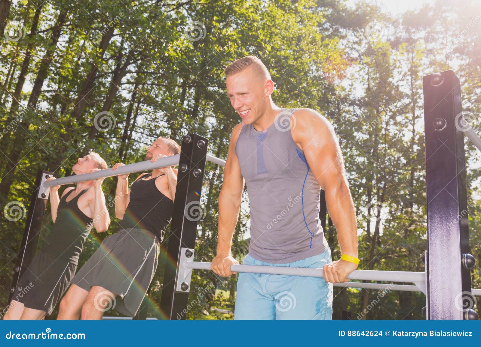 Friends doing pull-ups stock photo. Image of physical - 88642624