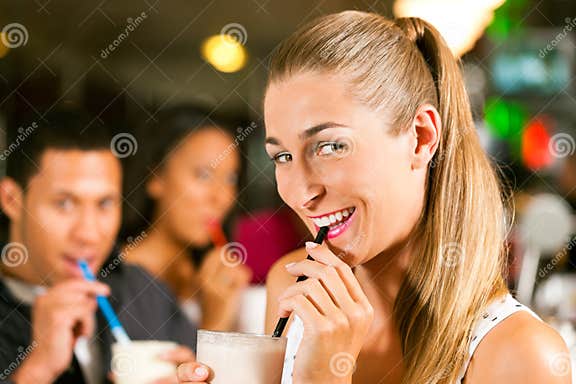 Friends Drinking Milkshakes in a Bar Stock Photo - Image of drink ...