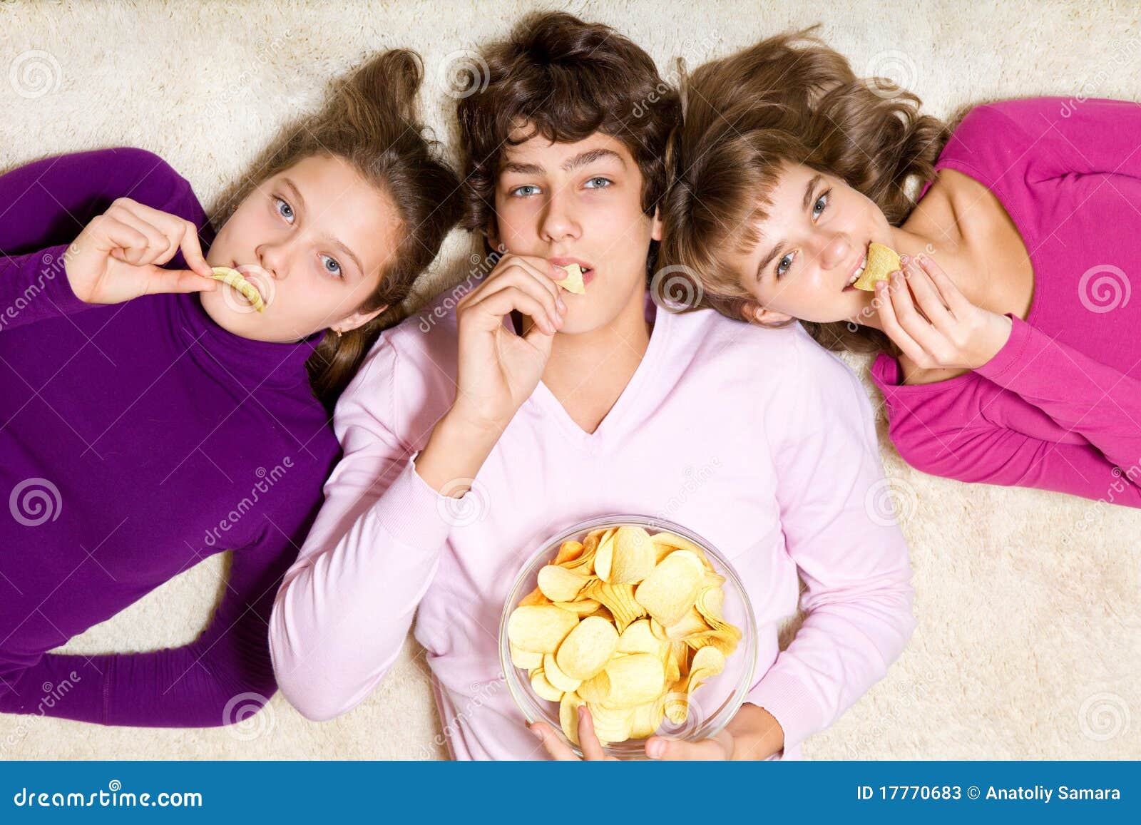 Friends eating crisps stock image. Image of junk, beautiful - 17770683