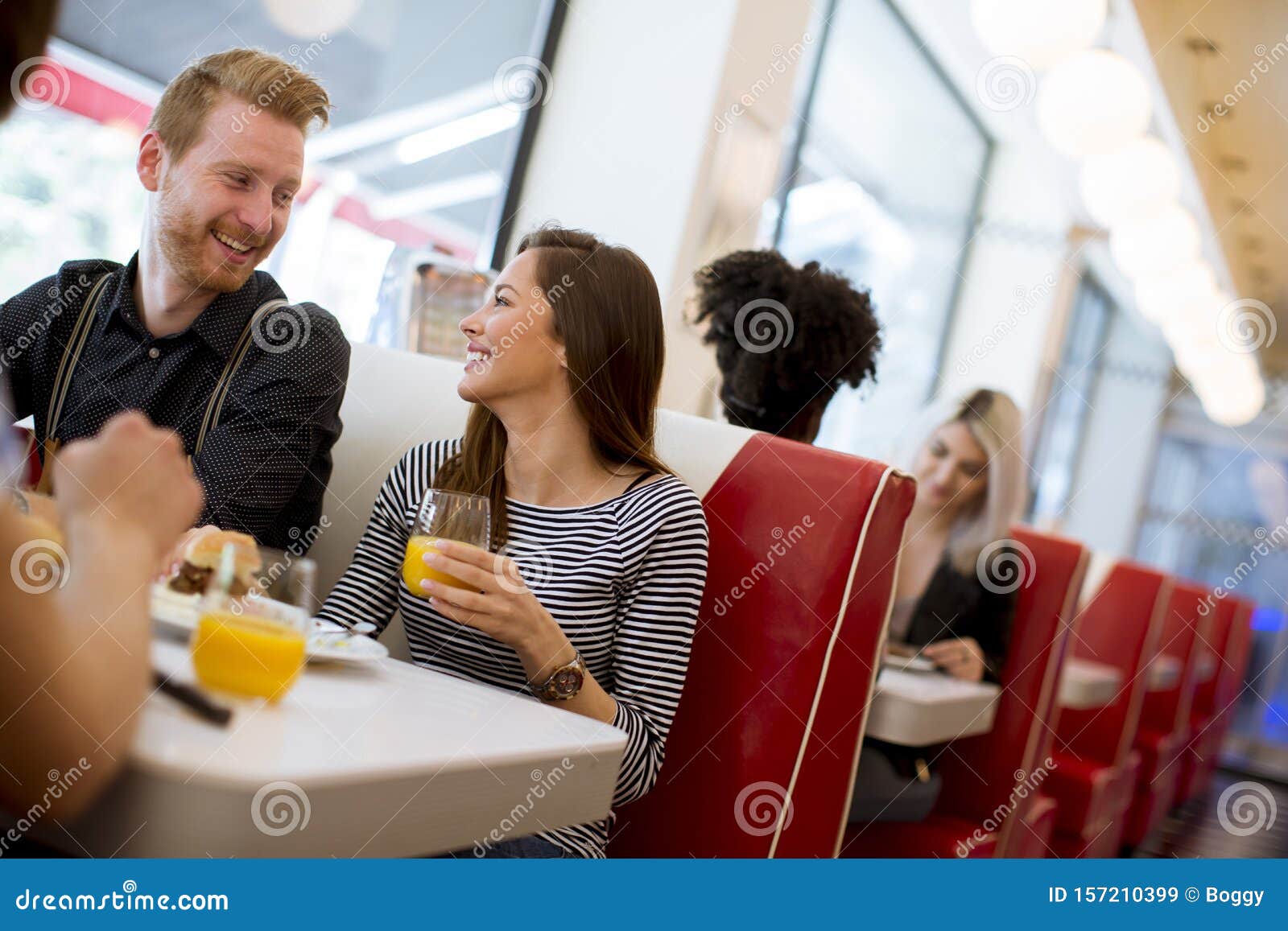 Friends Eating at the Table in the Diner Stock Image - Image of meal ...