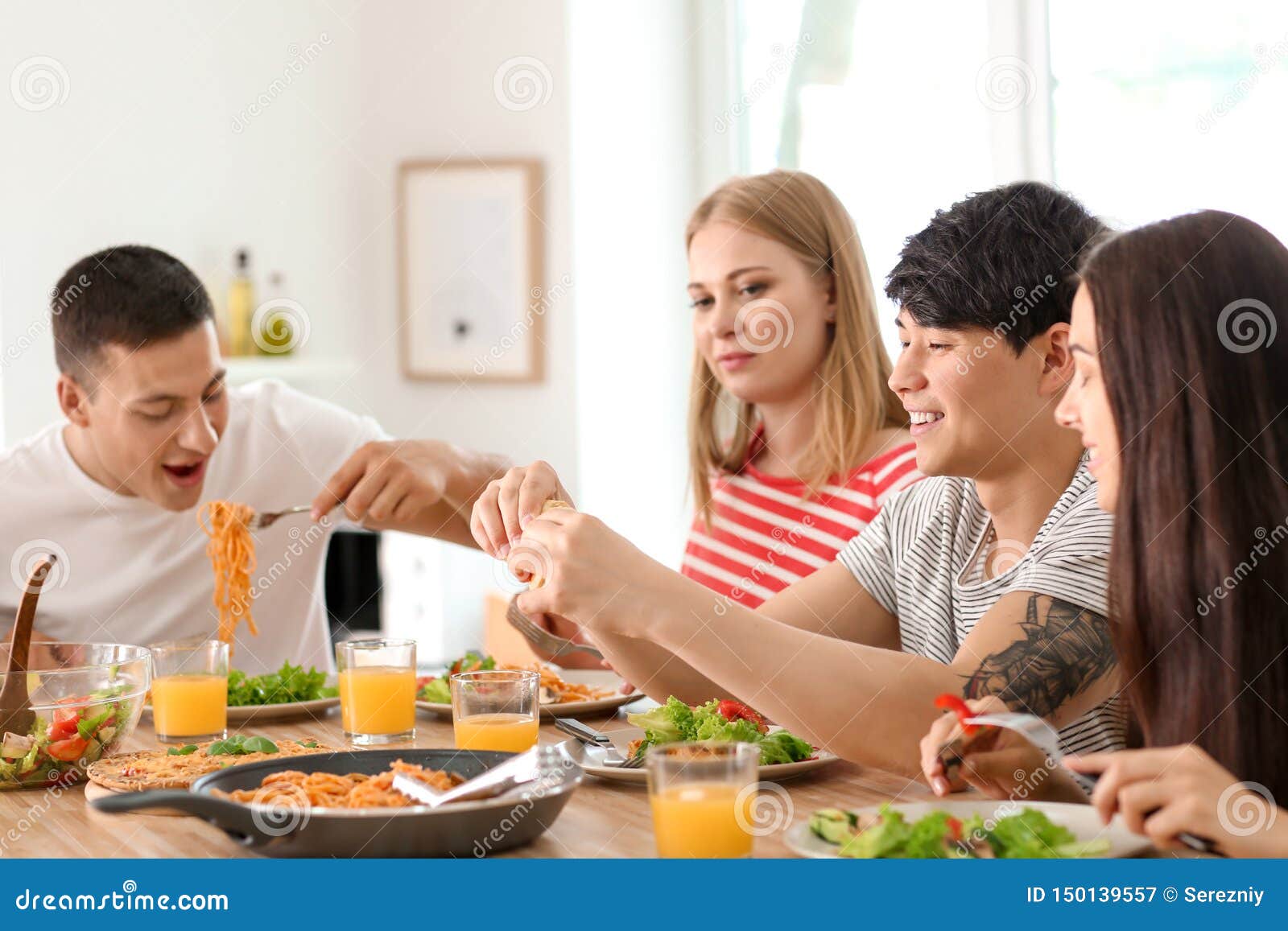 Friends Eating at Table in Kitchen Stock Image - Image of pasta, dinner ...