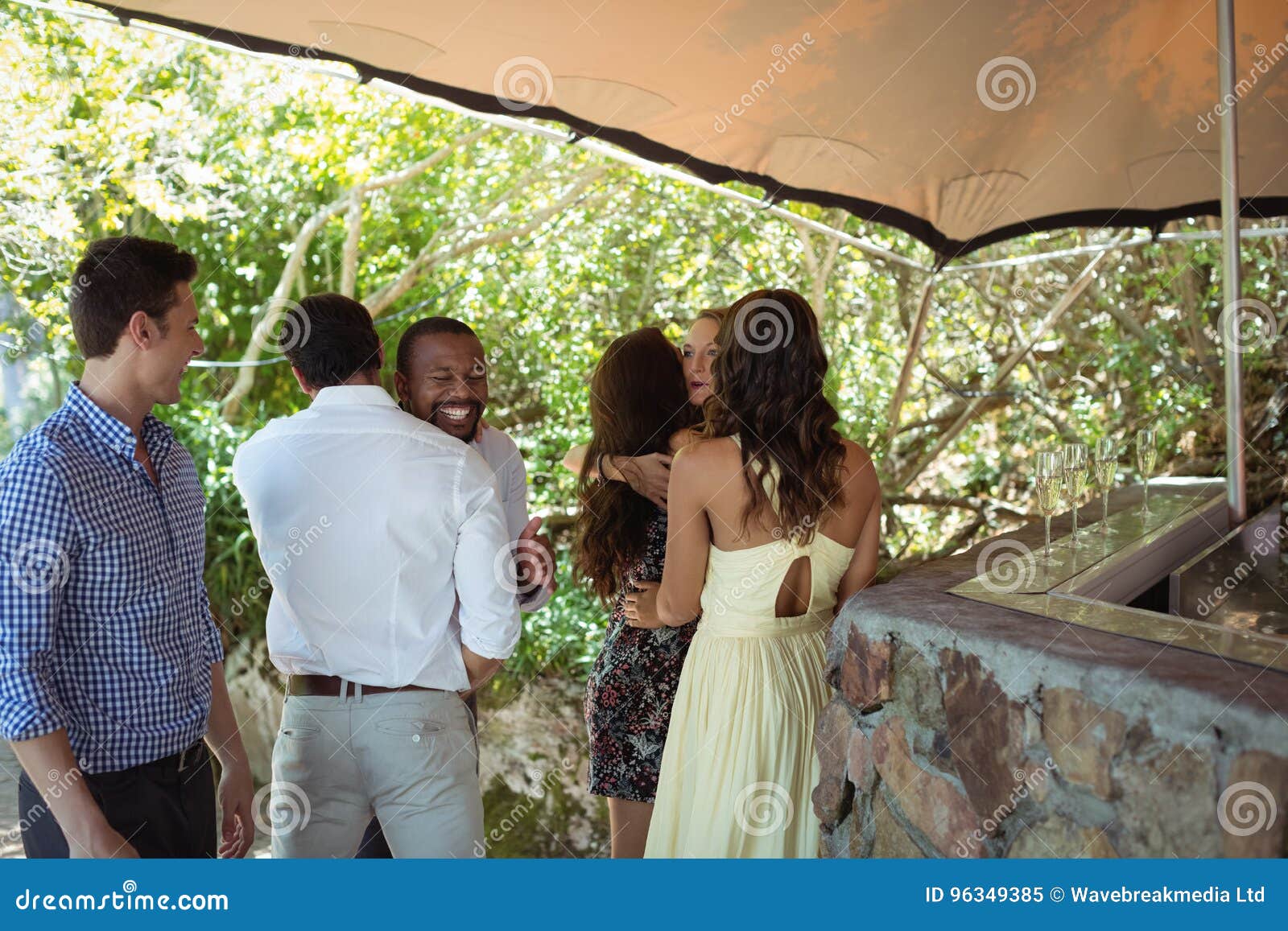 Friends Embracing Each Other at Counter Stock Image - Image of cheerful ...