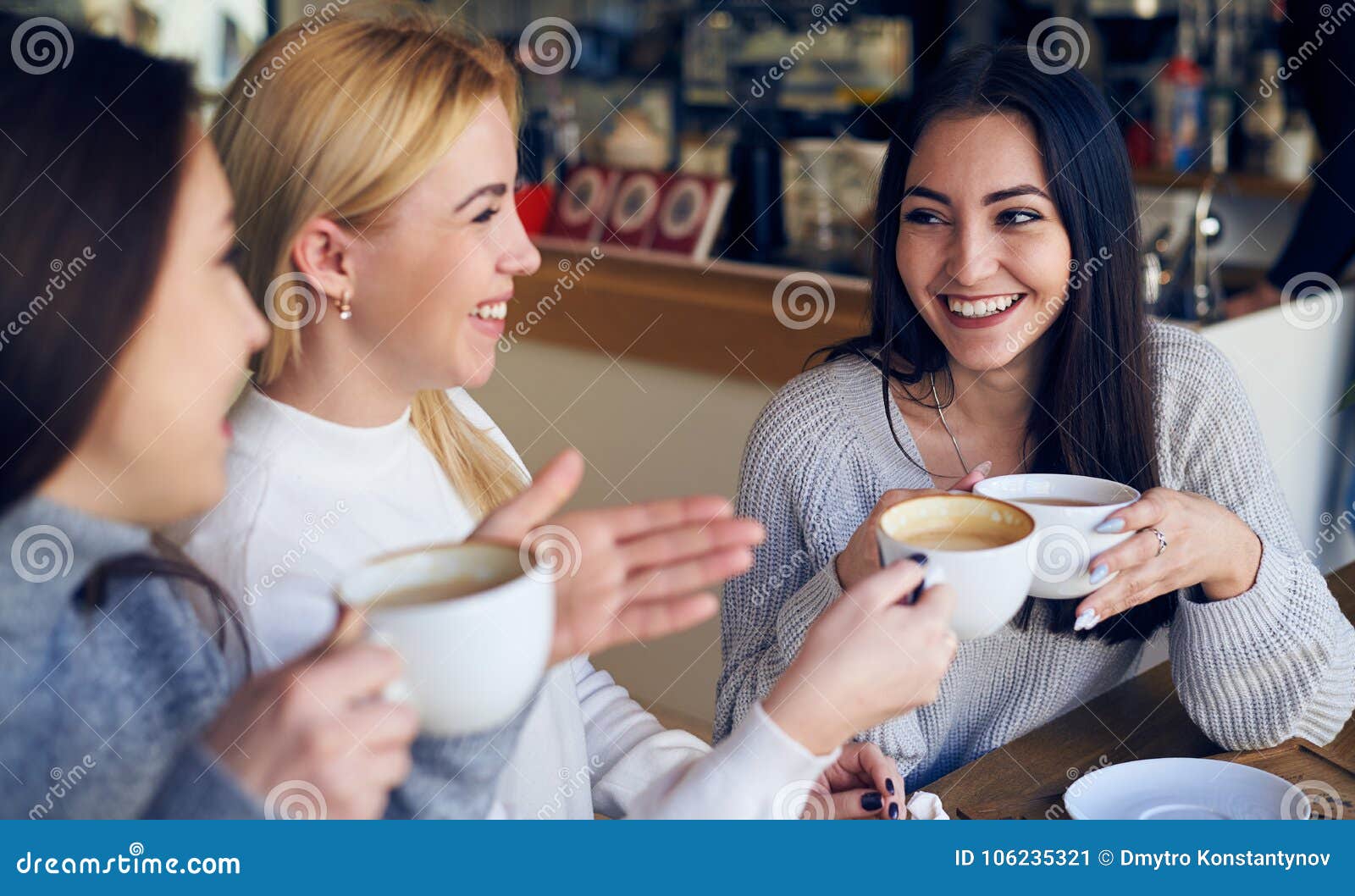 Friends Enjoying Conversation and Drinking Coffee at Cafe Stock Image ...