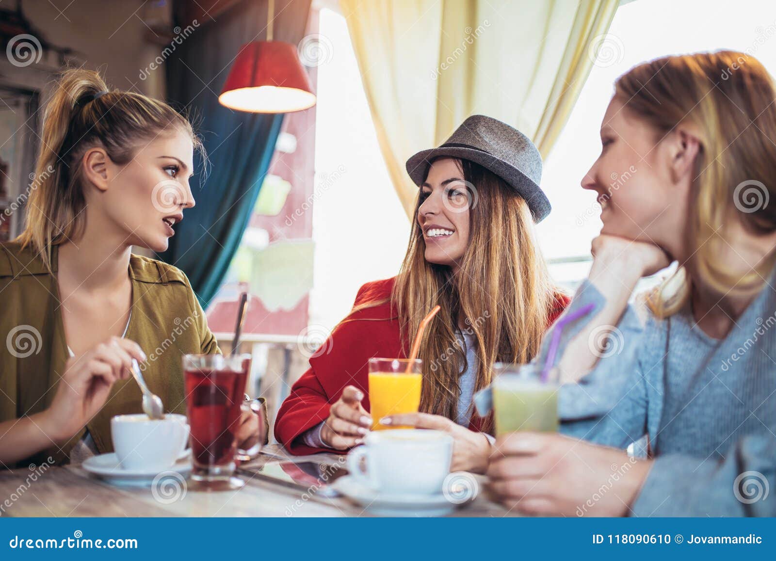 Friends Enjoying in Conversation and Drinking Coffee in Cafe Stock ...