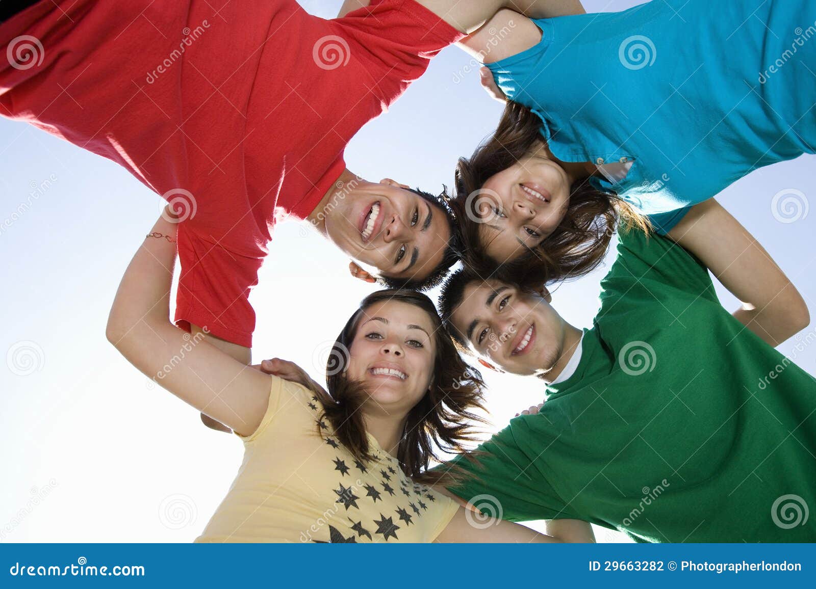 Friends Forming a Huddle Against Sky Stock Photo - Image of huddling ...