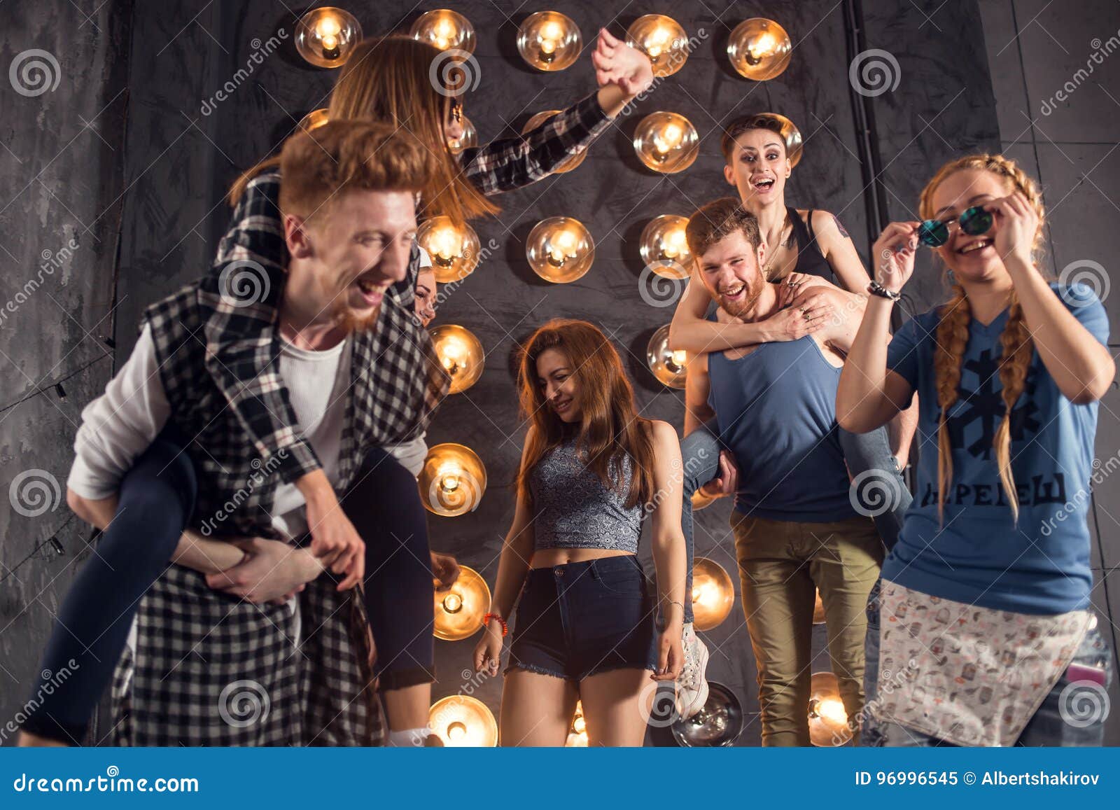 Friends Fun on the Studio Wall with Lamps Stock Image - Image of hands ...