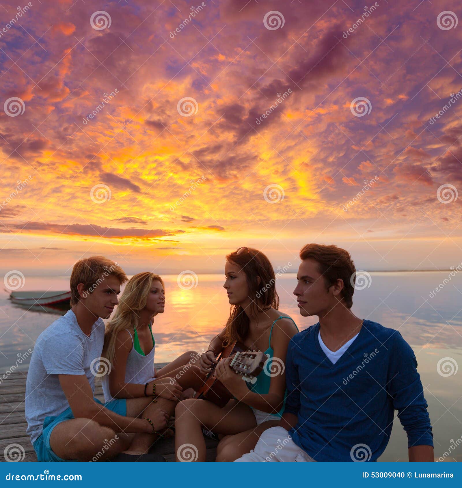 Friends Group at Sunset Beach Having Fun with Guitar Stock Photo ...