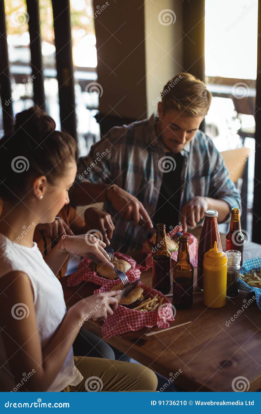 Friends Having Burger Together Stock Photo - Image of black, adult ...