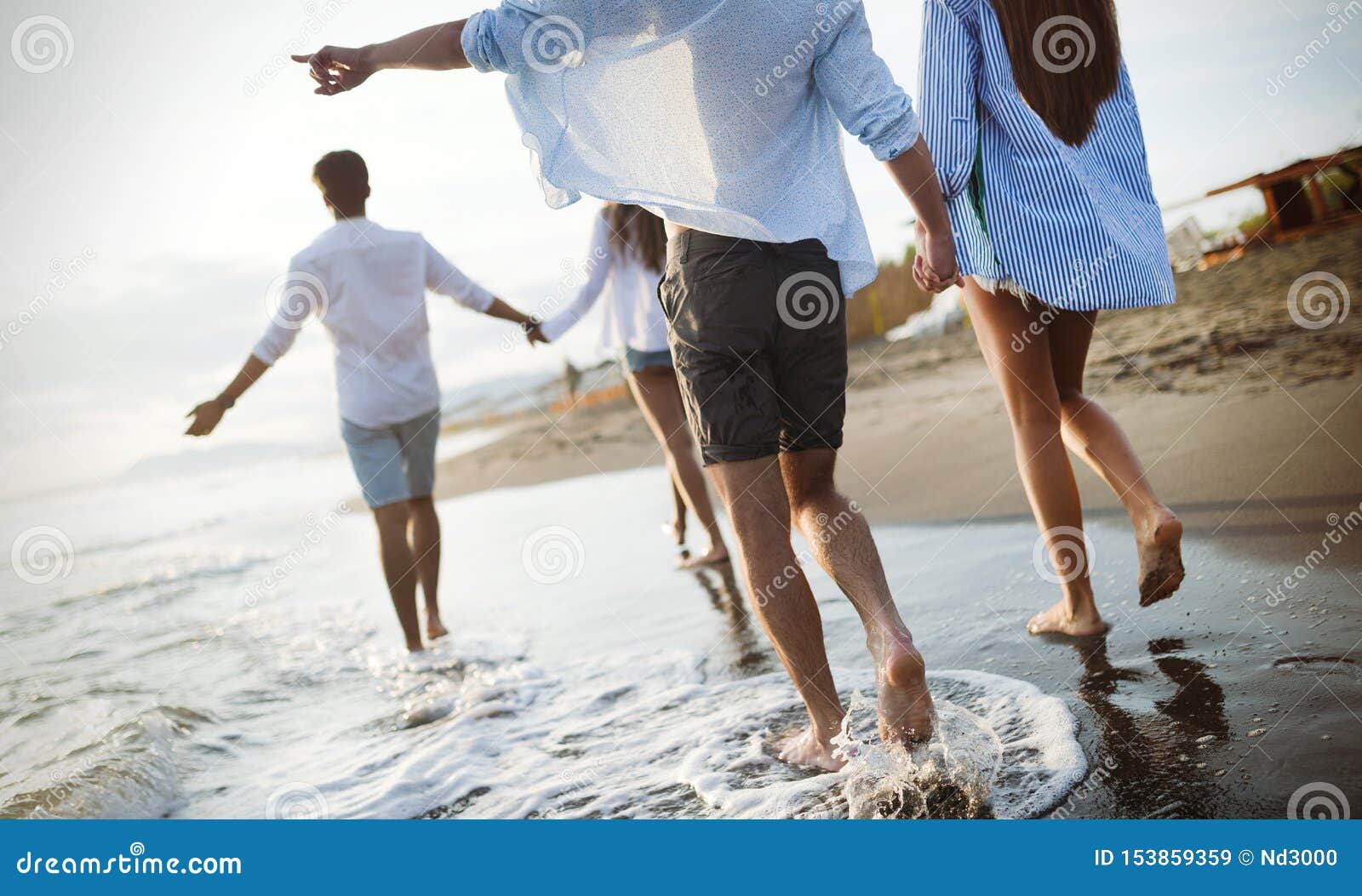 Friends Having Fun on the Beach Under Sunset Sunlight. Stock Image ...
