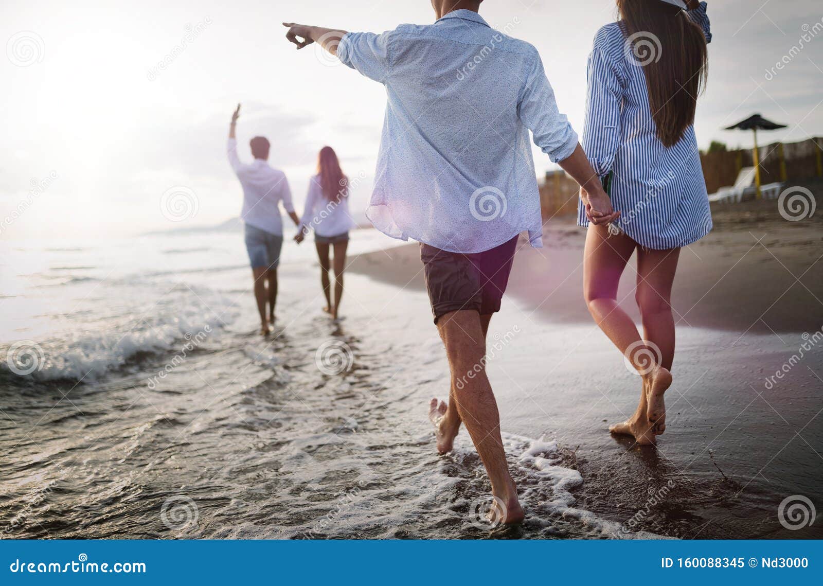 Friends Having Fun on the Beach Under Sunset Sunlight. Stock Image ...